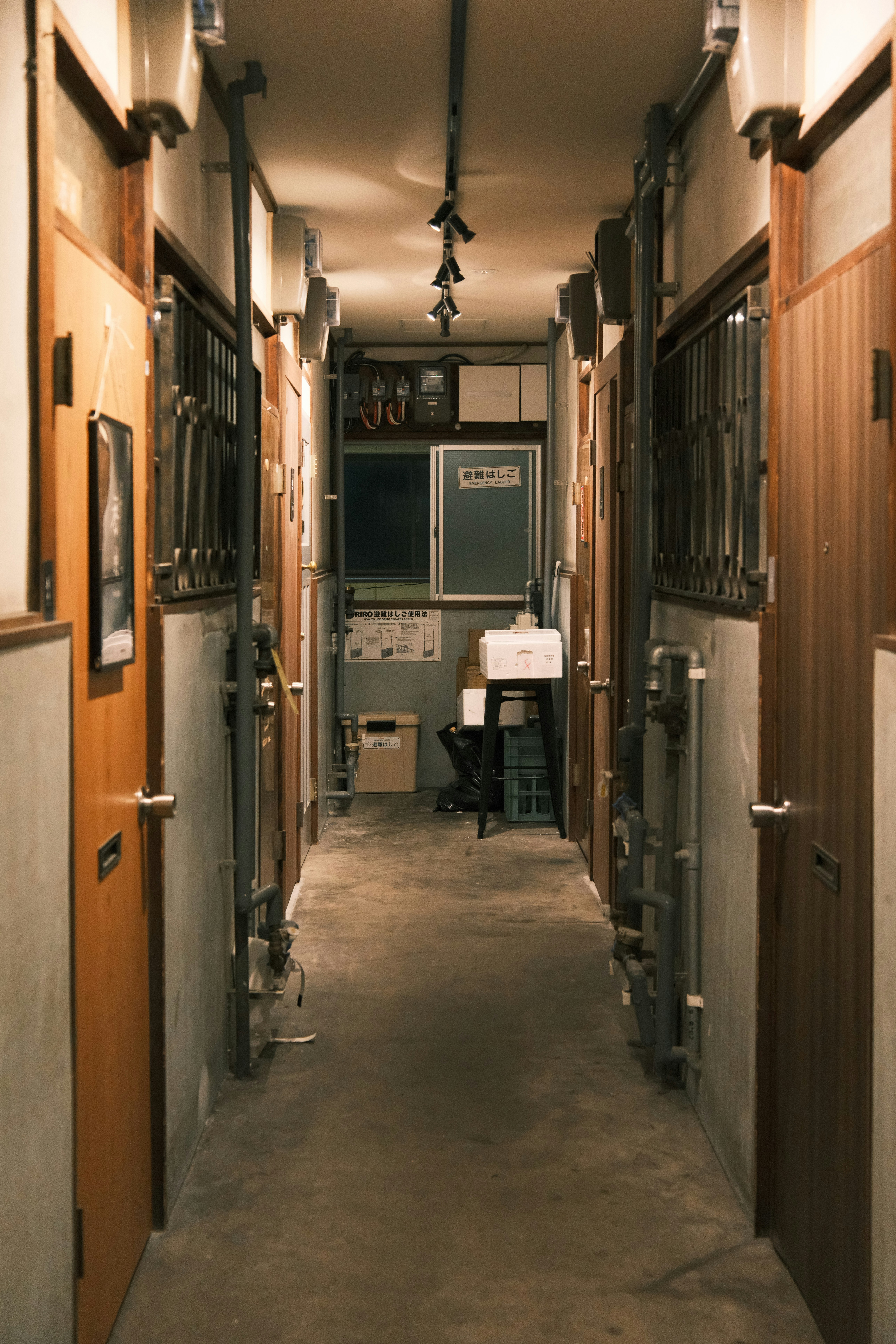 Backroom Corridor: Boxes, Doors and Warm Light