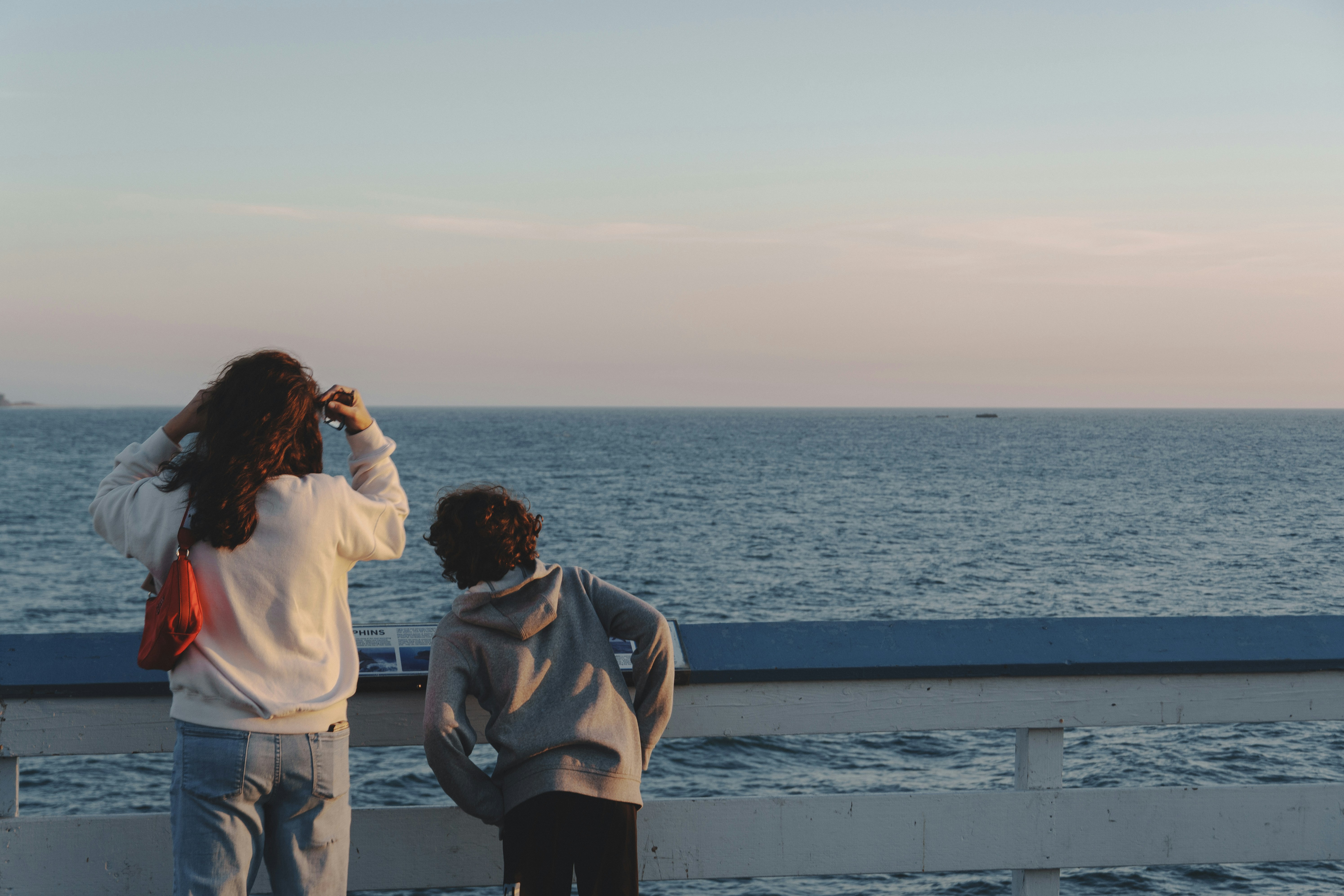 Coastal Window: Two Figures Gaze Toward the Horizon