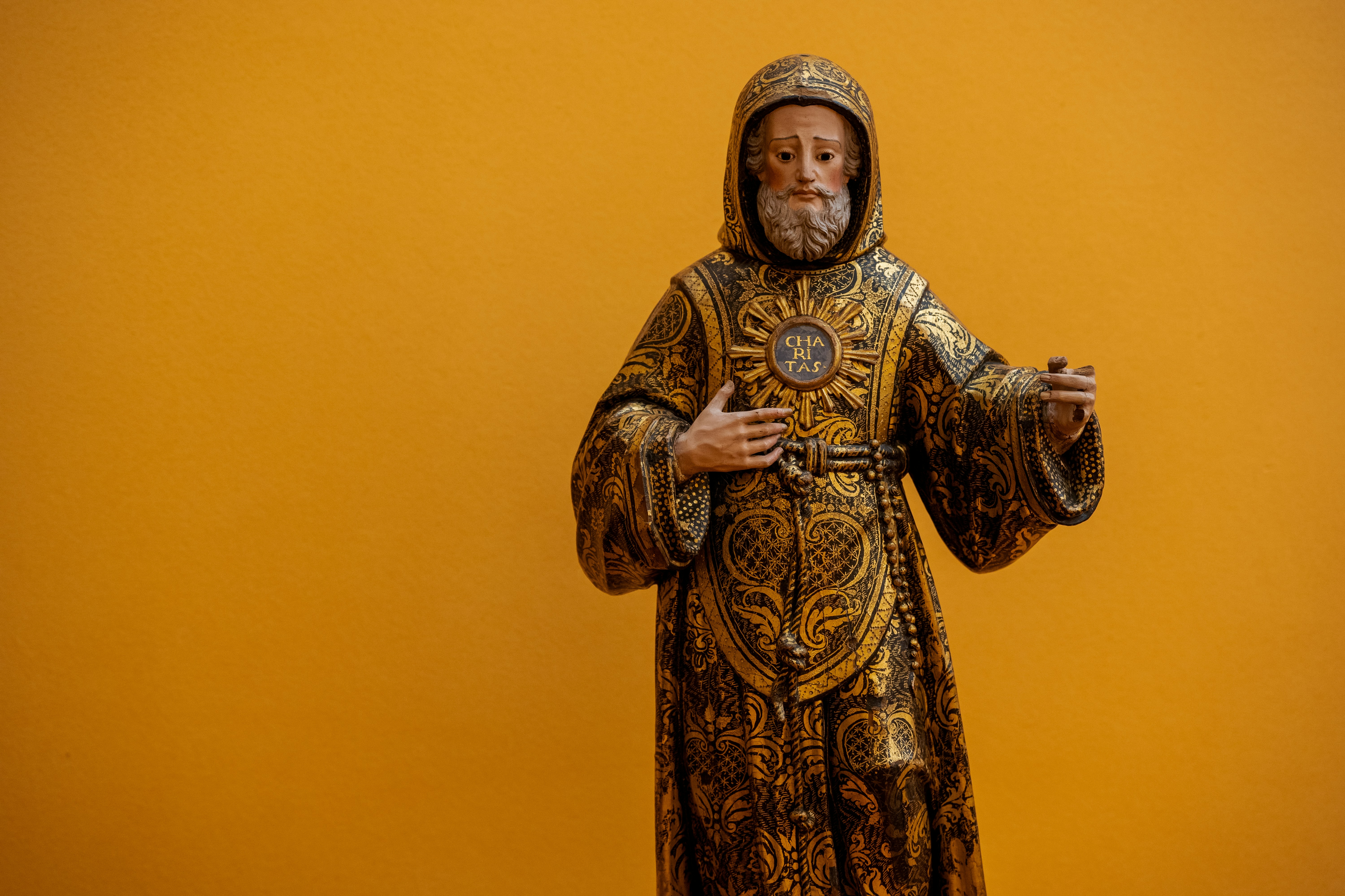 A golden statue of a monk stands posed. photo – Free Portugal Image on ...