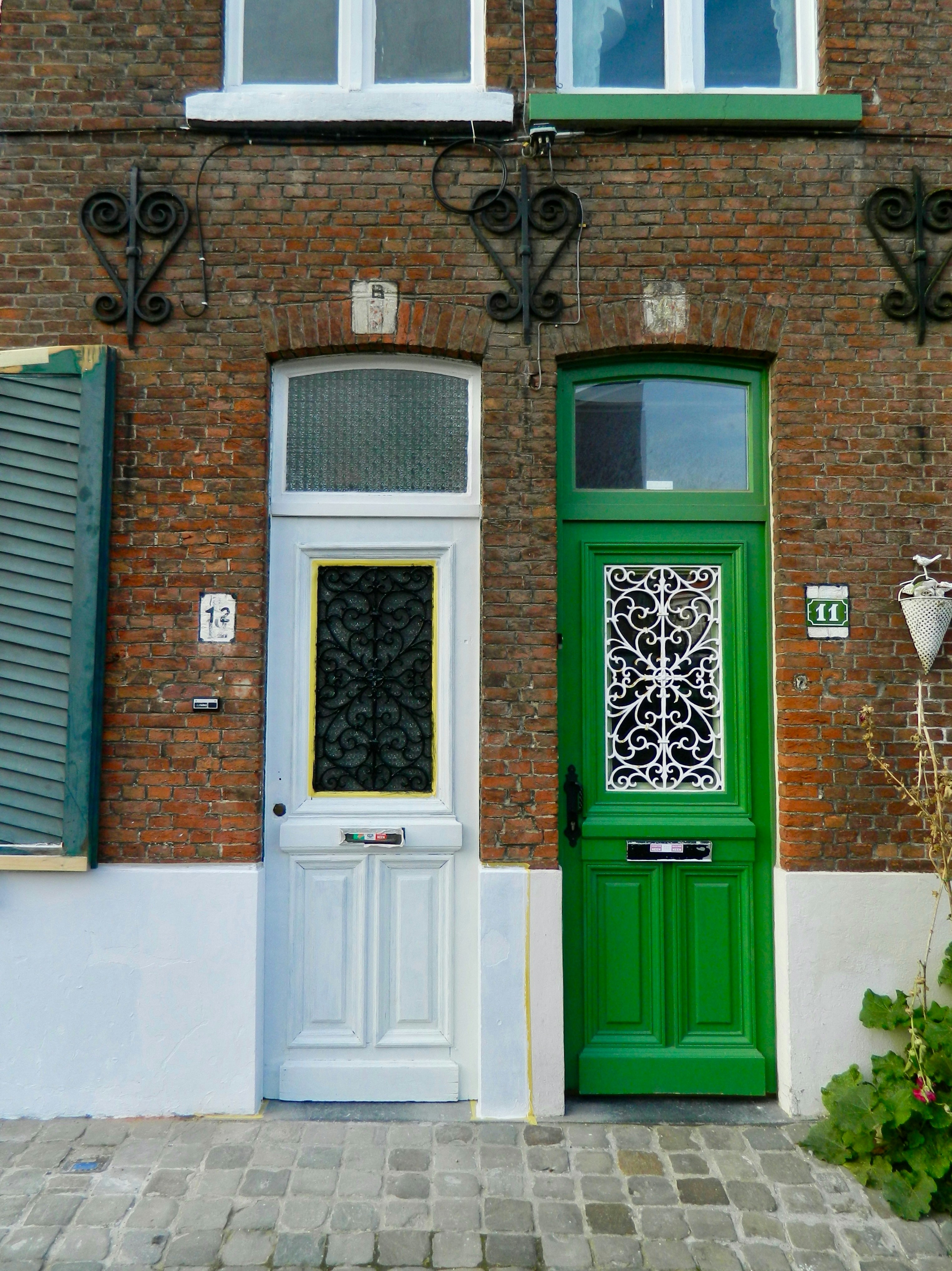 Two-Tone Doorway: A Brick Facade Between Light and Lime