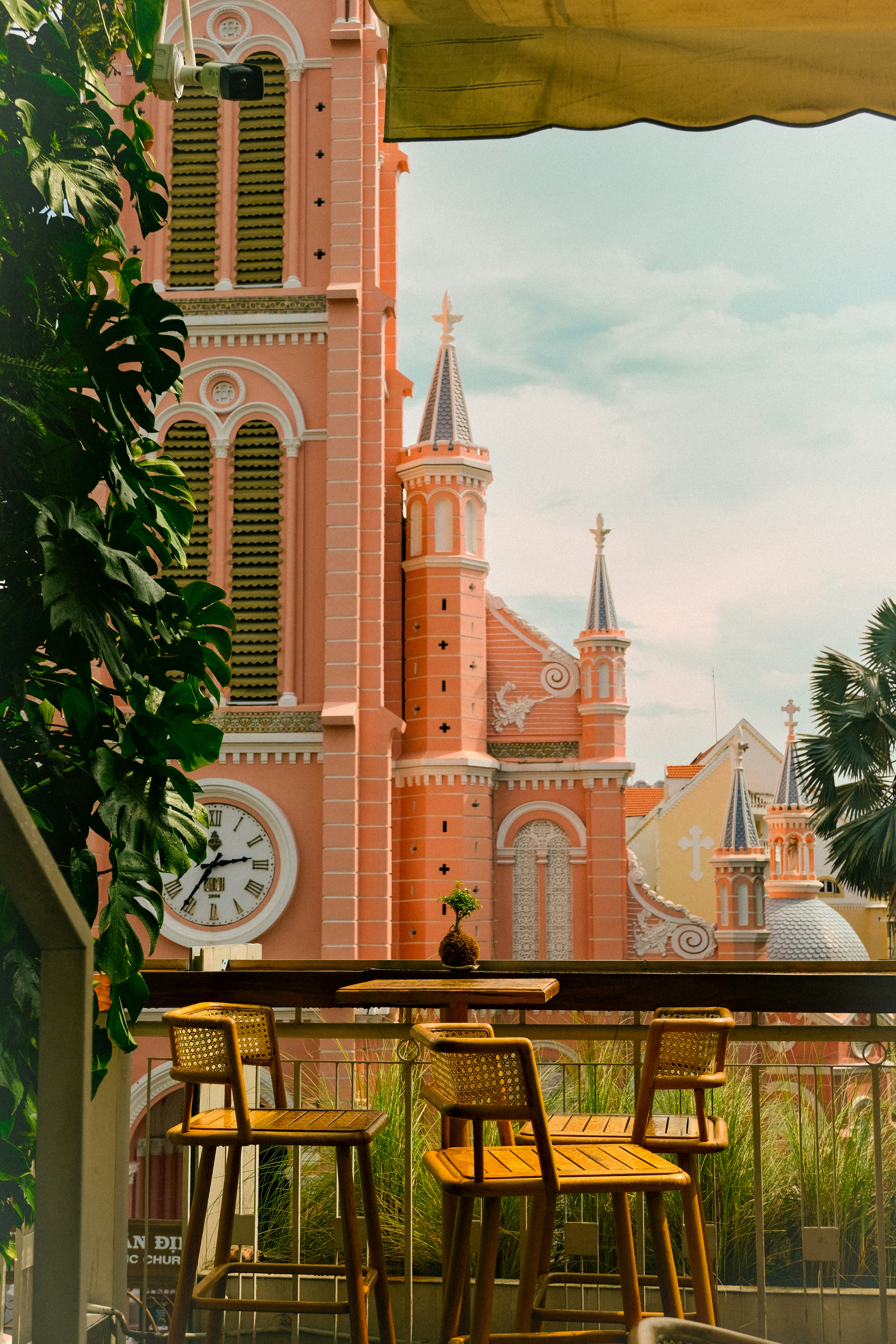 Cafe Terrace Against a Peach Cathedral: Turrets Rise in Soft Daylight