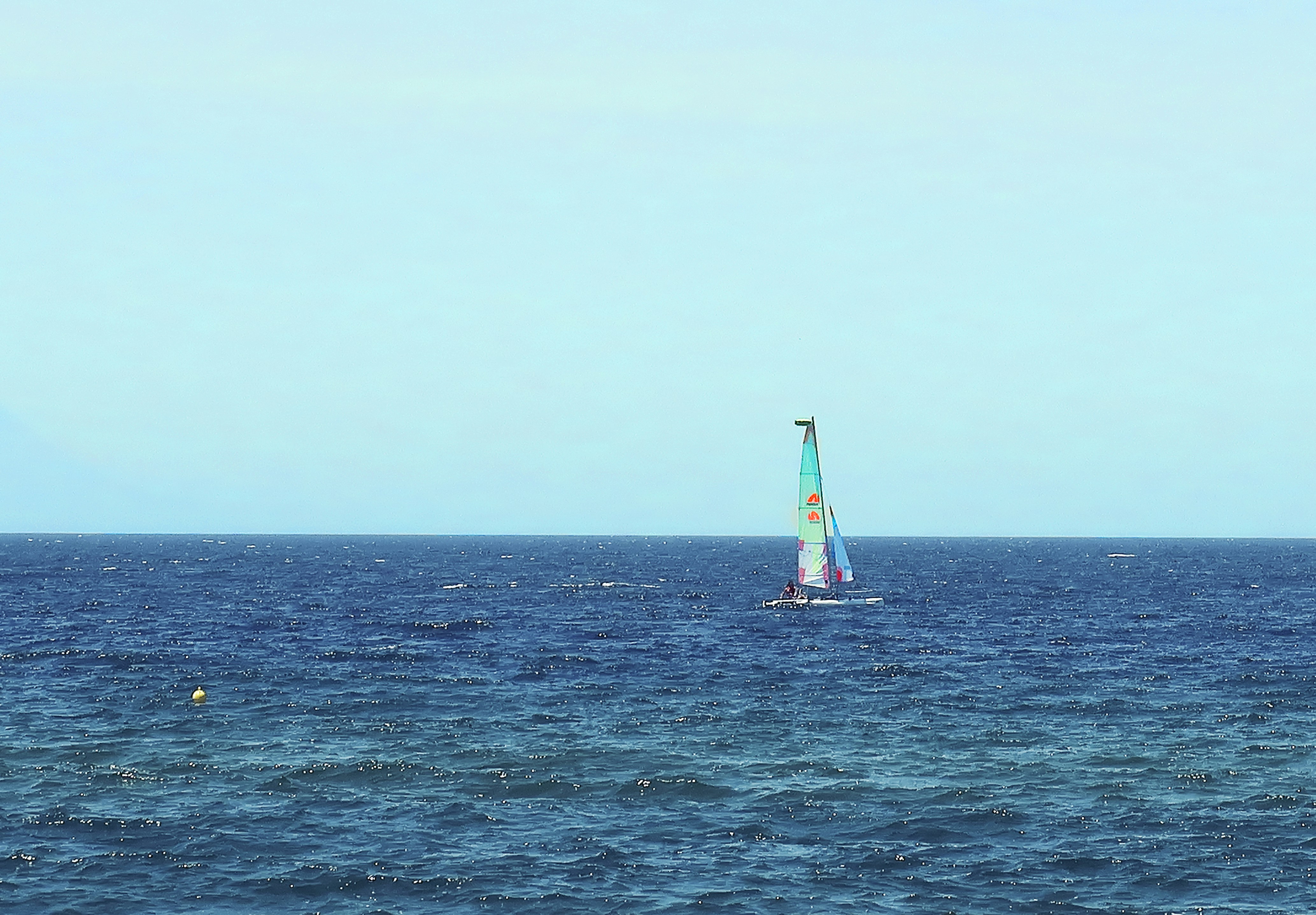 A windsurfer sails gracefully on the ocean. photo – Free Sea Image on ...