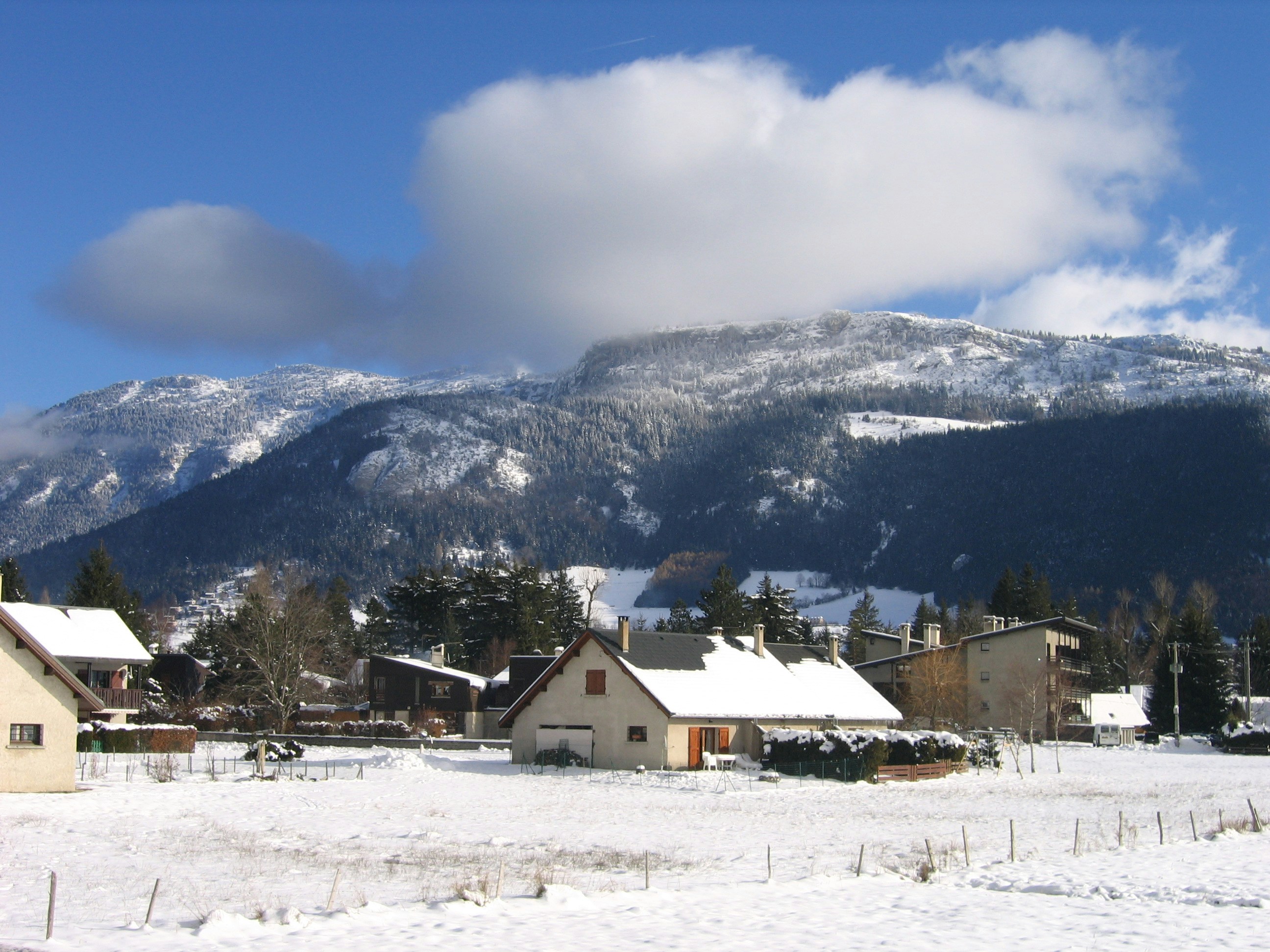 Snowy village beneath the mountain peaks.