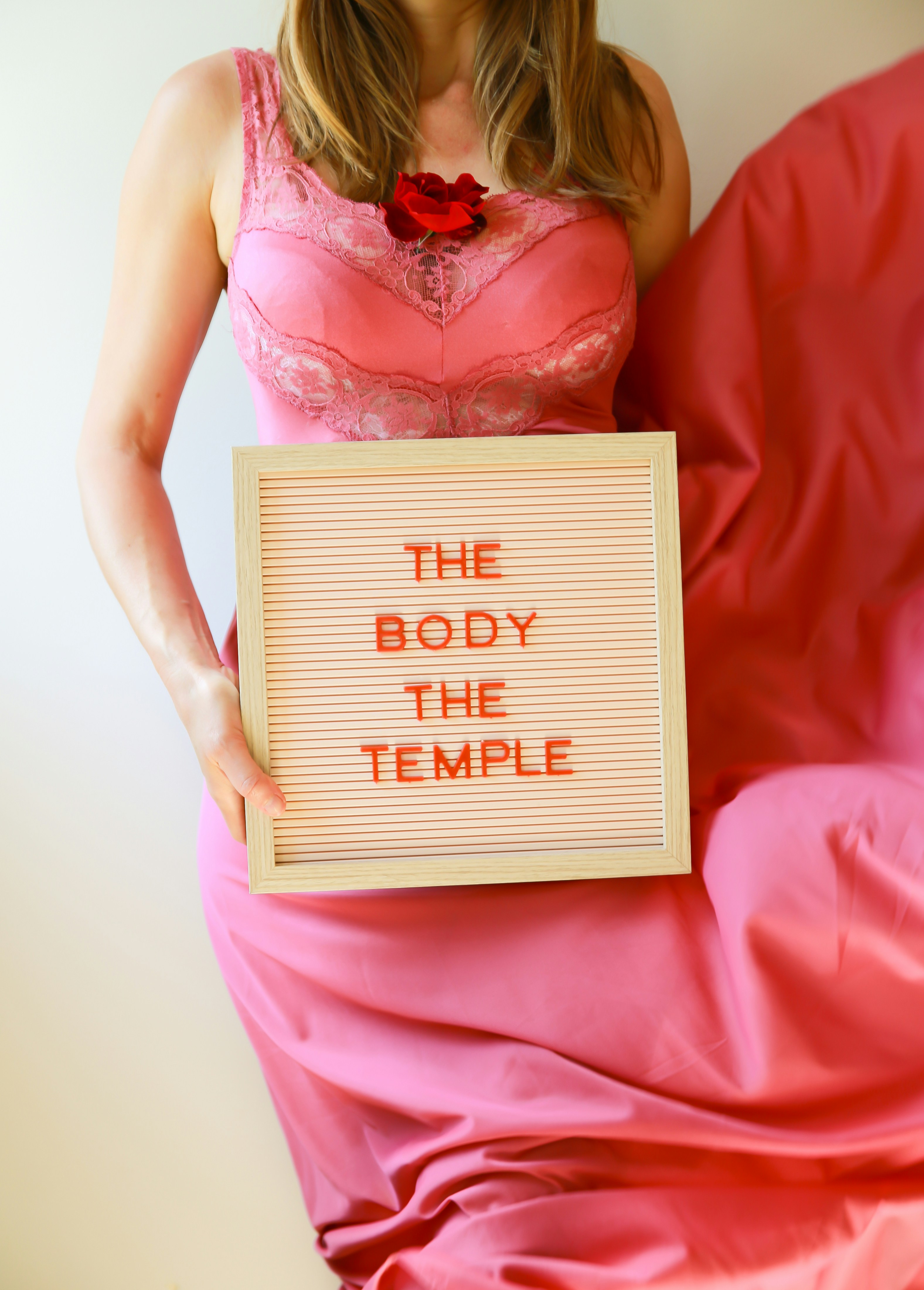 A woman holds a sign: "the body, the temple." photo – Free Woman Image ...