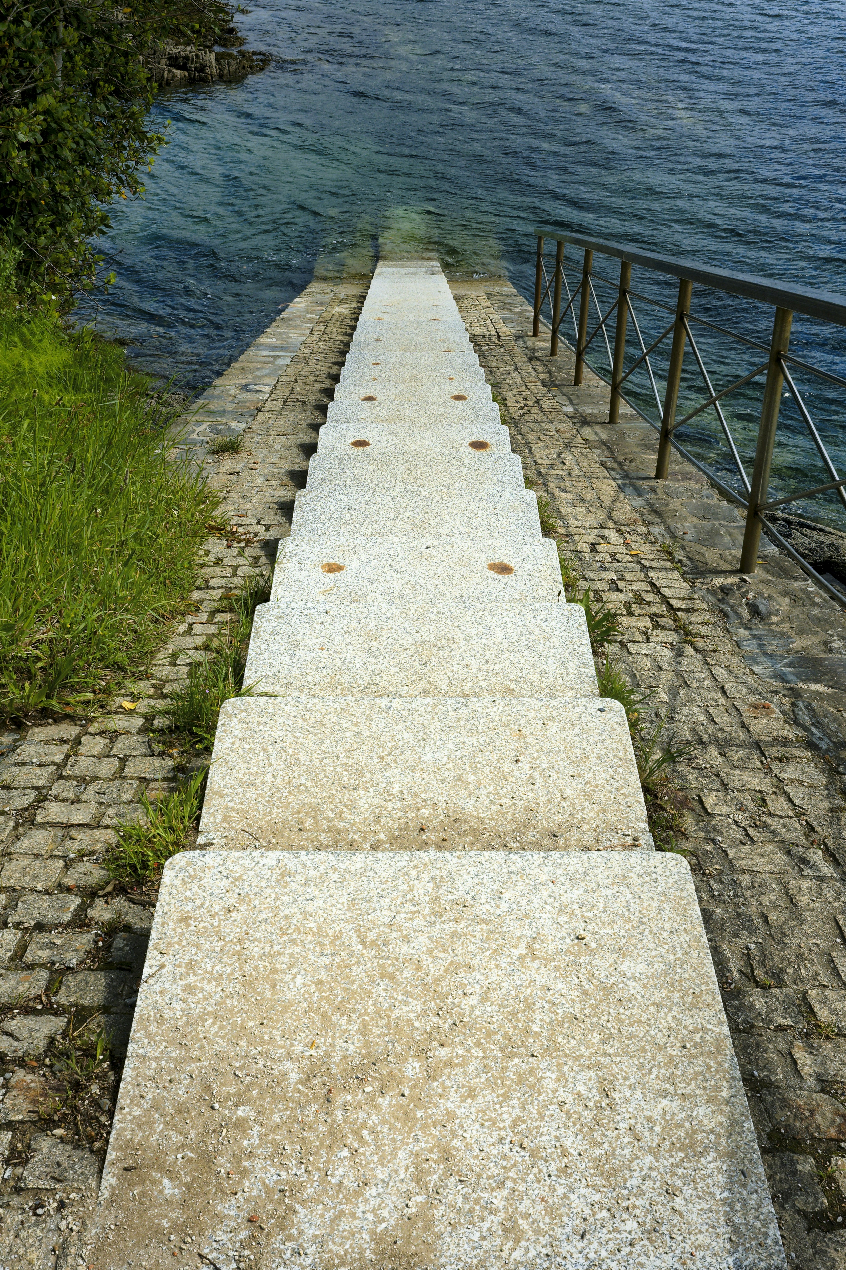 Converging Steps to the Sea: Weathered Concrete Descent Toward Turquoise Waters