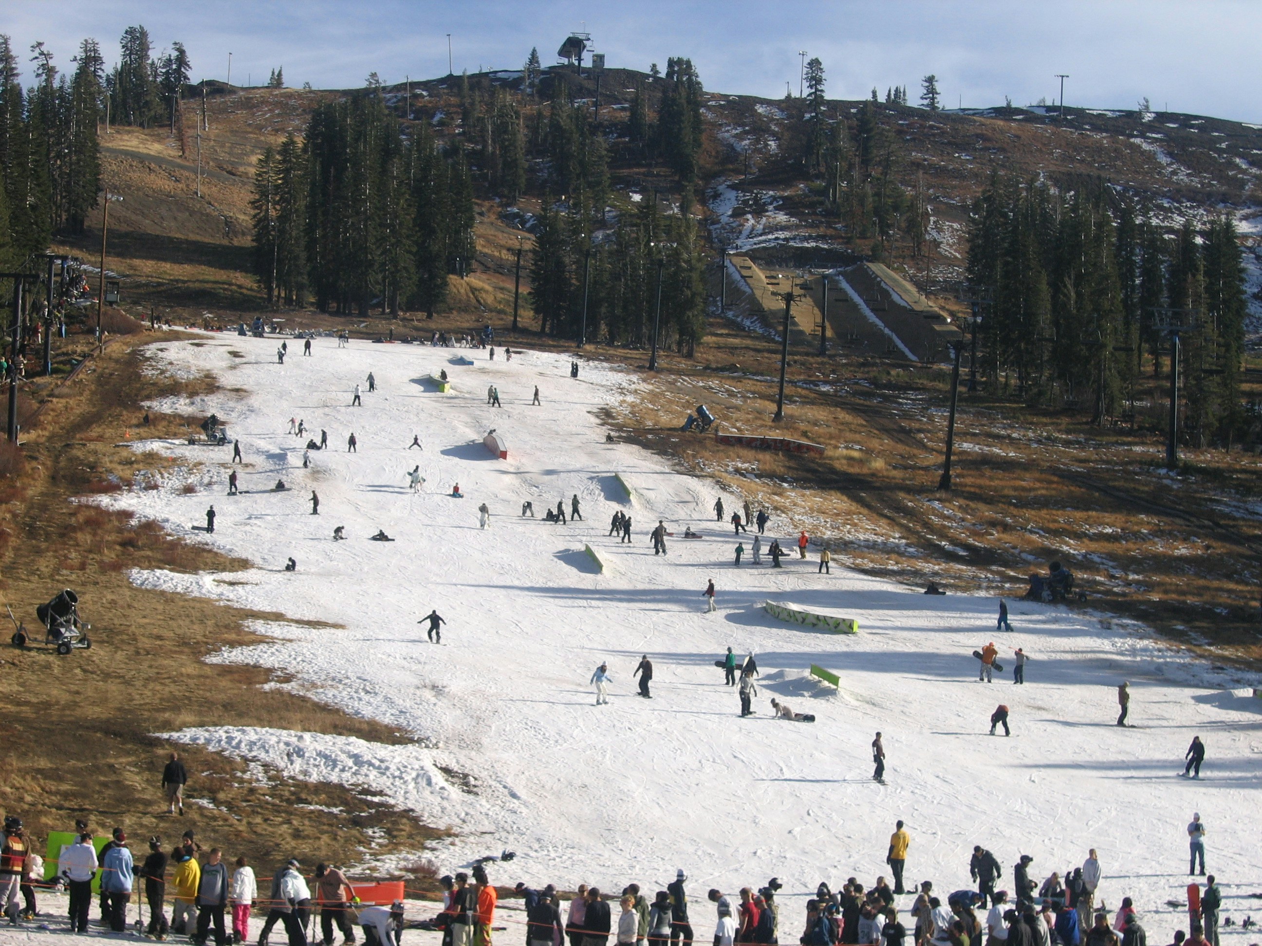 People are skiing and snowboarding on a snowy slope.