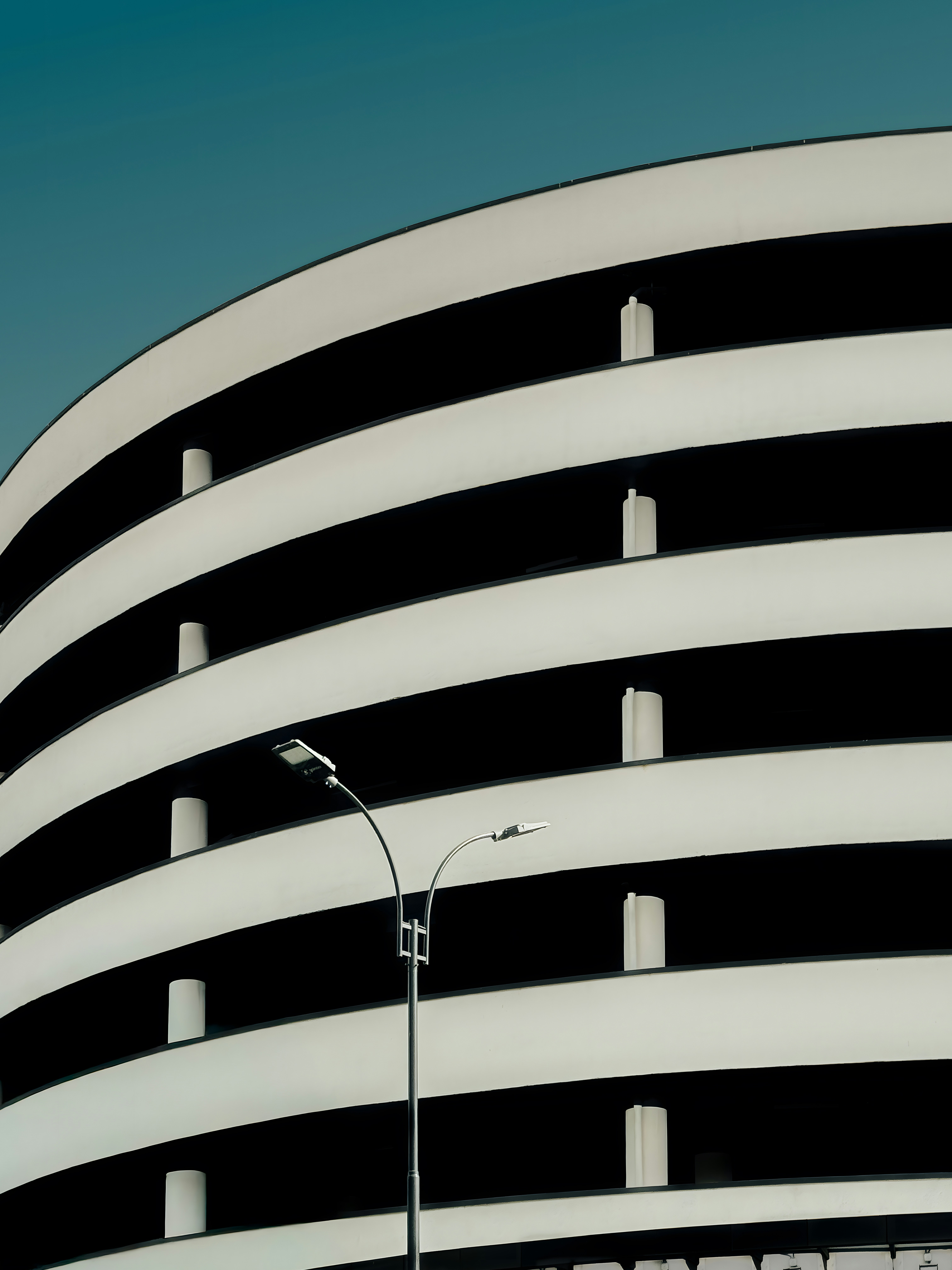 Concentric Ramps under a Cerulean Sky, with a Lone Streetlamp