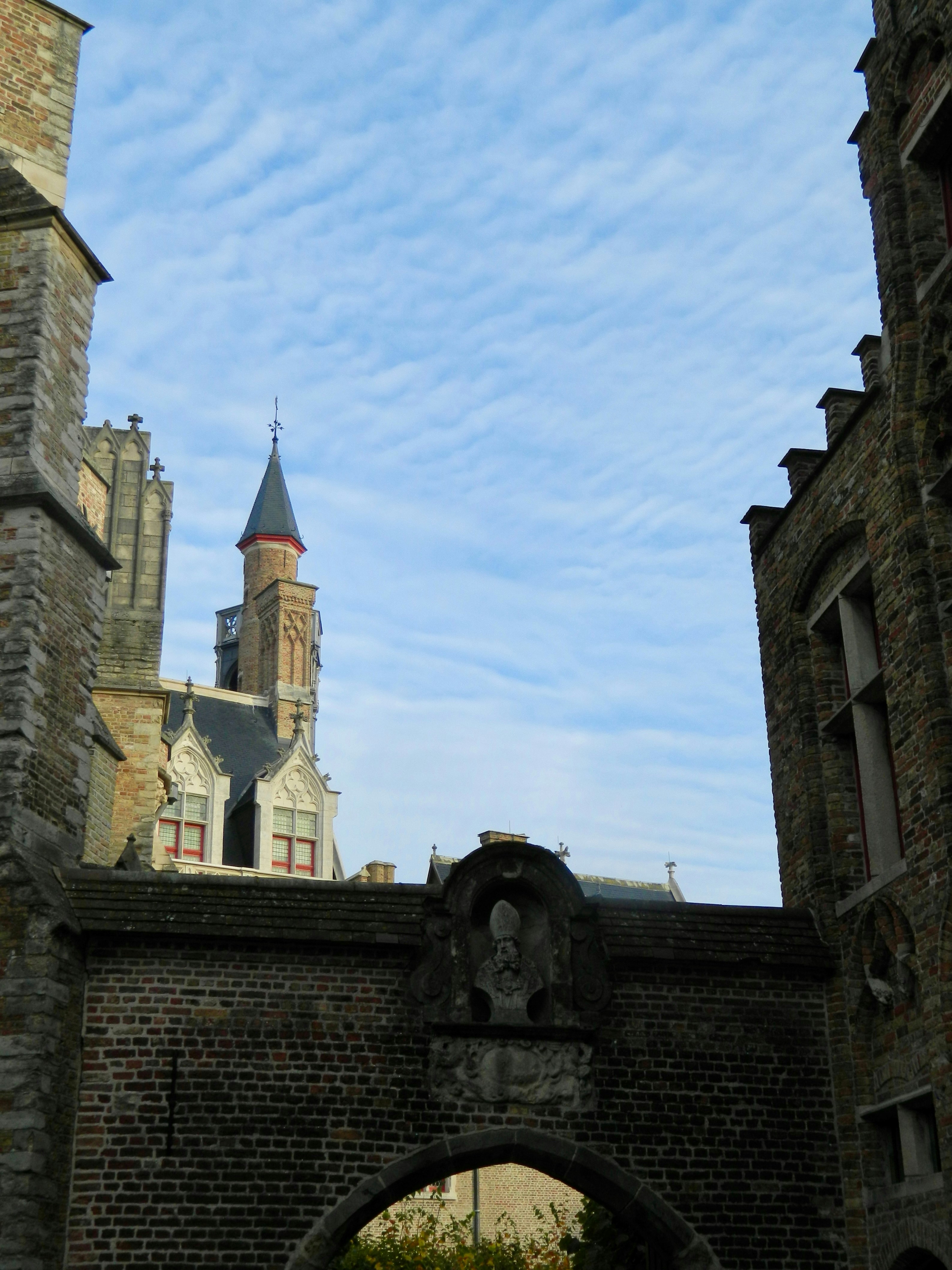 Gothic Archway Framing a Skyward Clocktower
