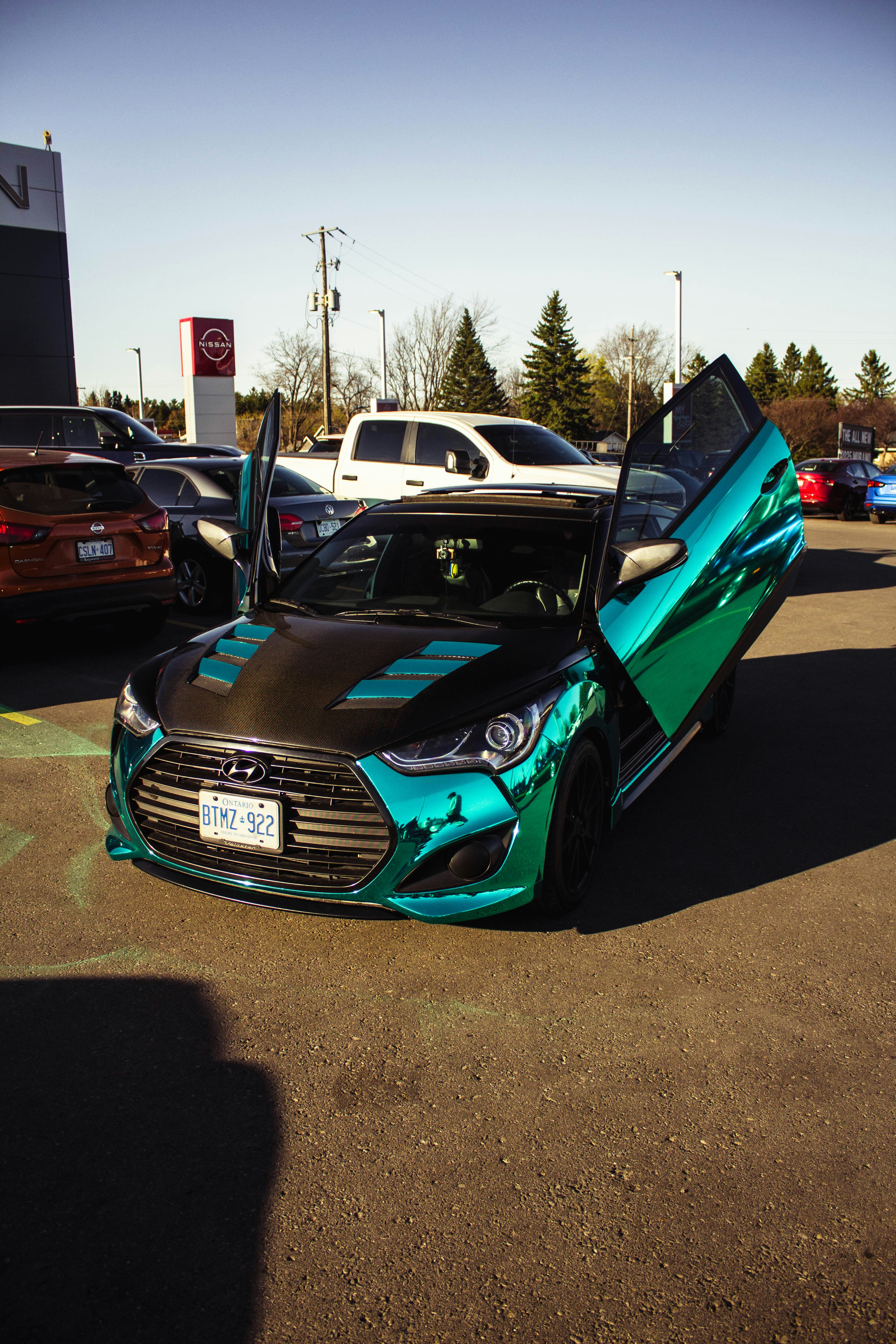 Emerald Hyundai with Butterfly Doors in a Sunlit Car Lot