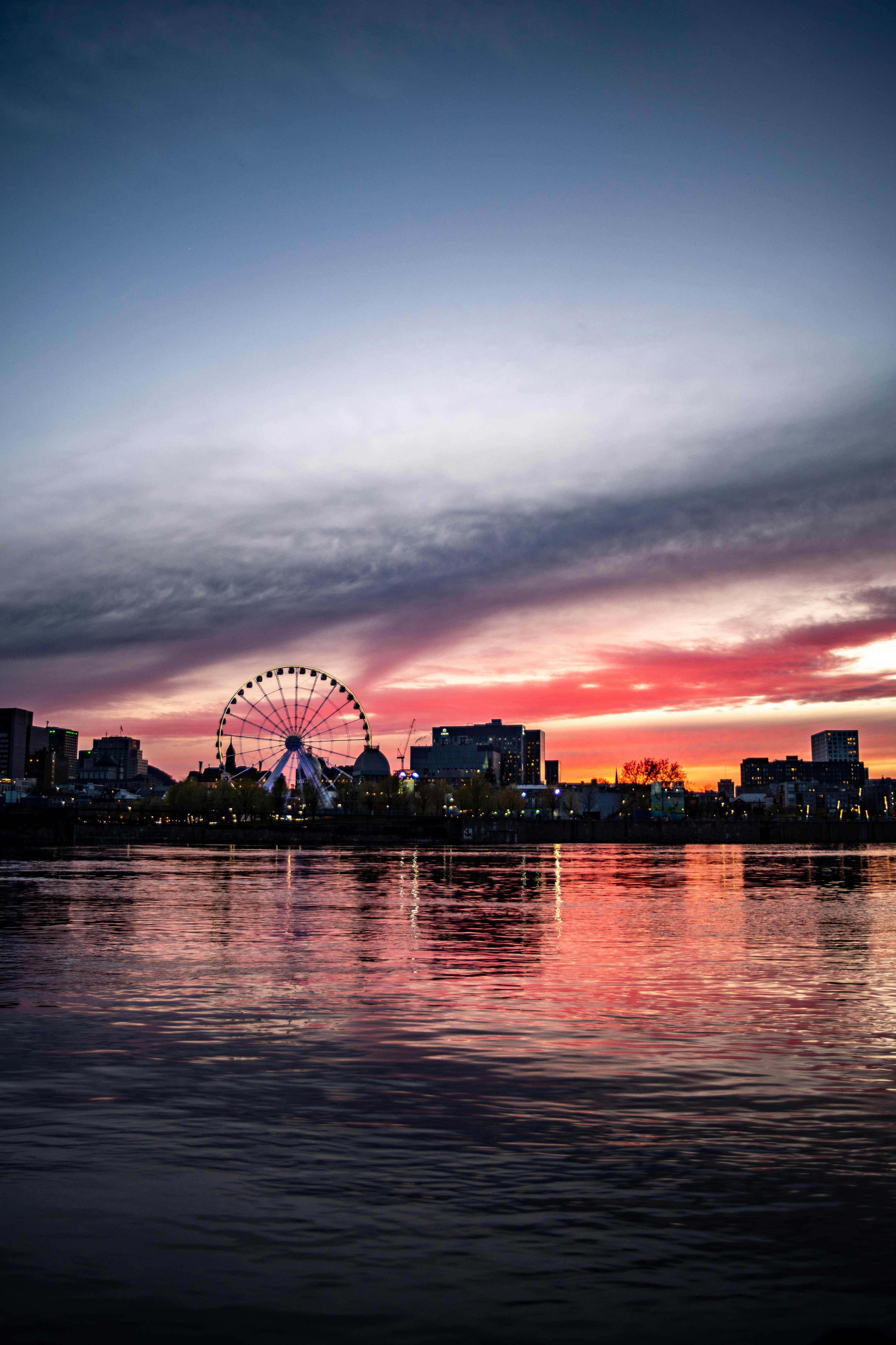 Sunset illuminates the city skyline and the ferris wheel. photo – Free ...