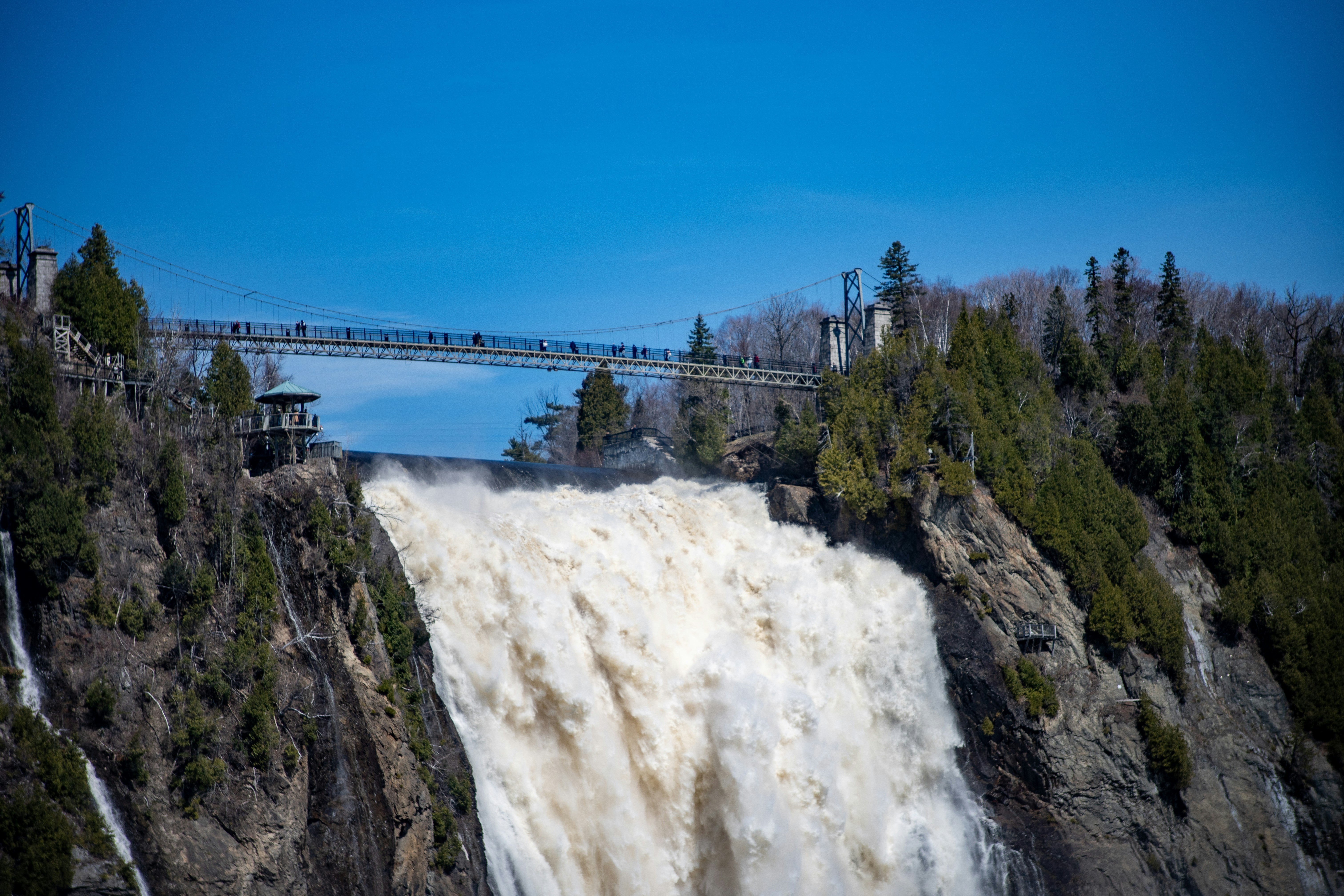 A majestic waterfall cascades beneath a bridge. photo – Free Forest ...