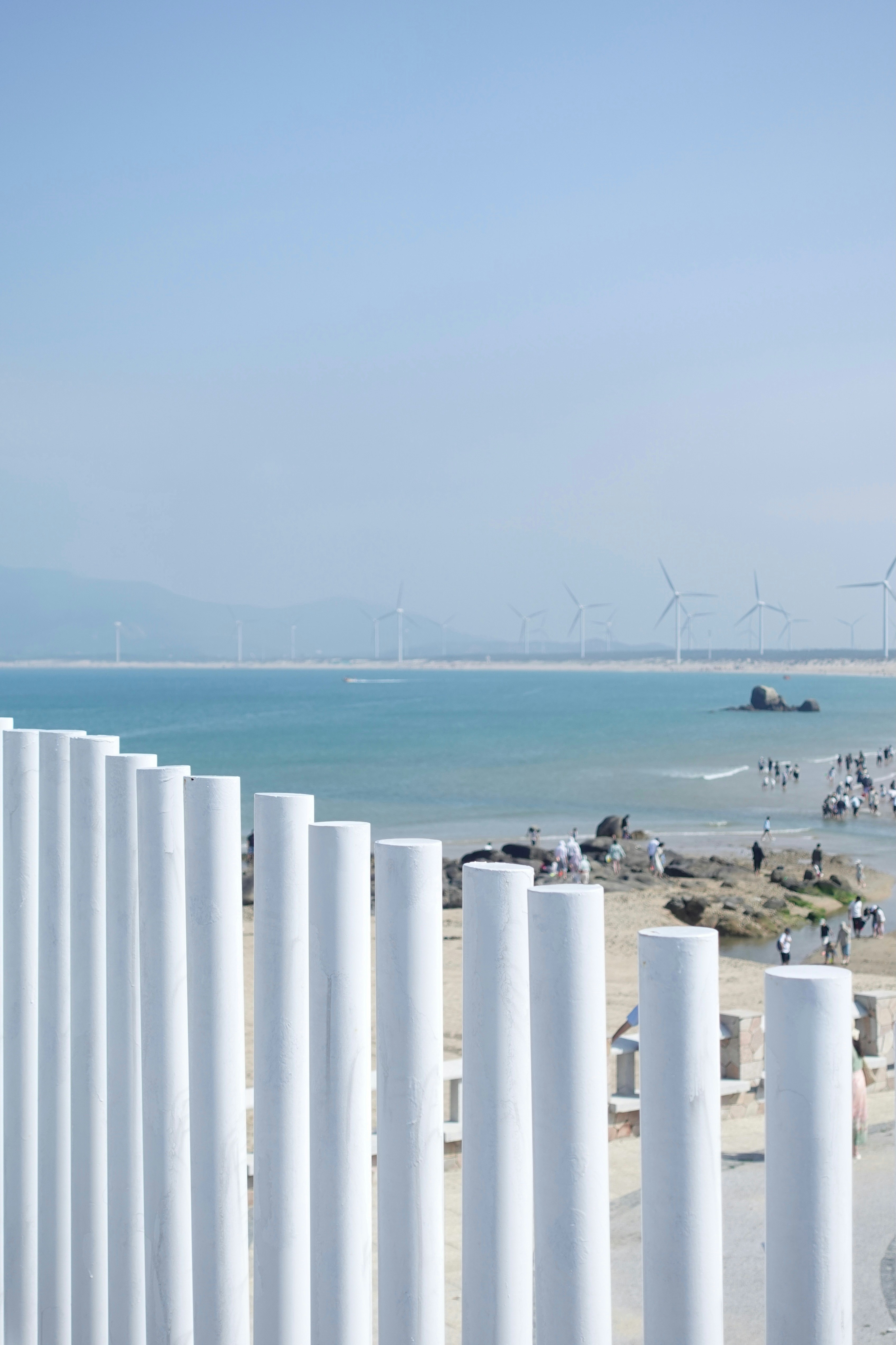 Pillars of Light: A Seaside Corridor Toward Wind Turbines
