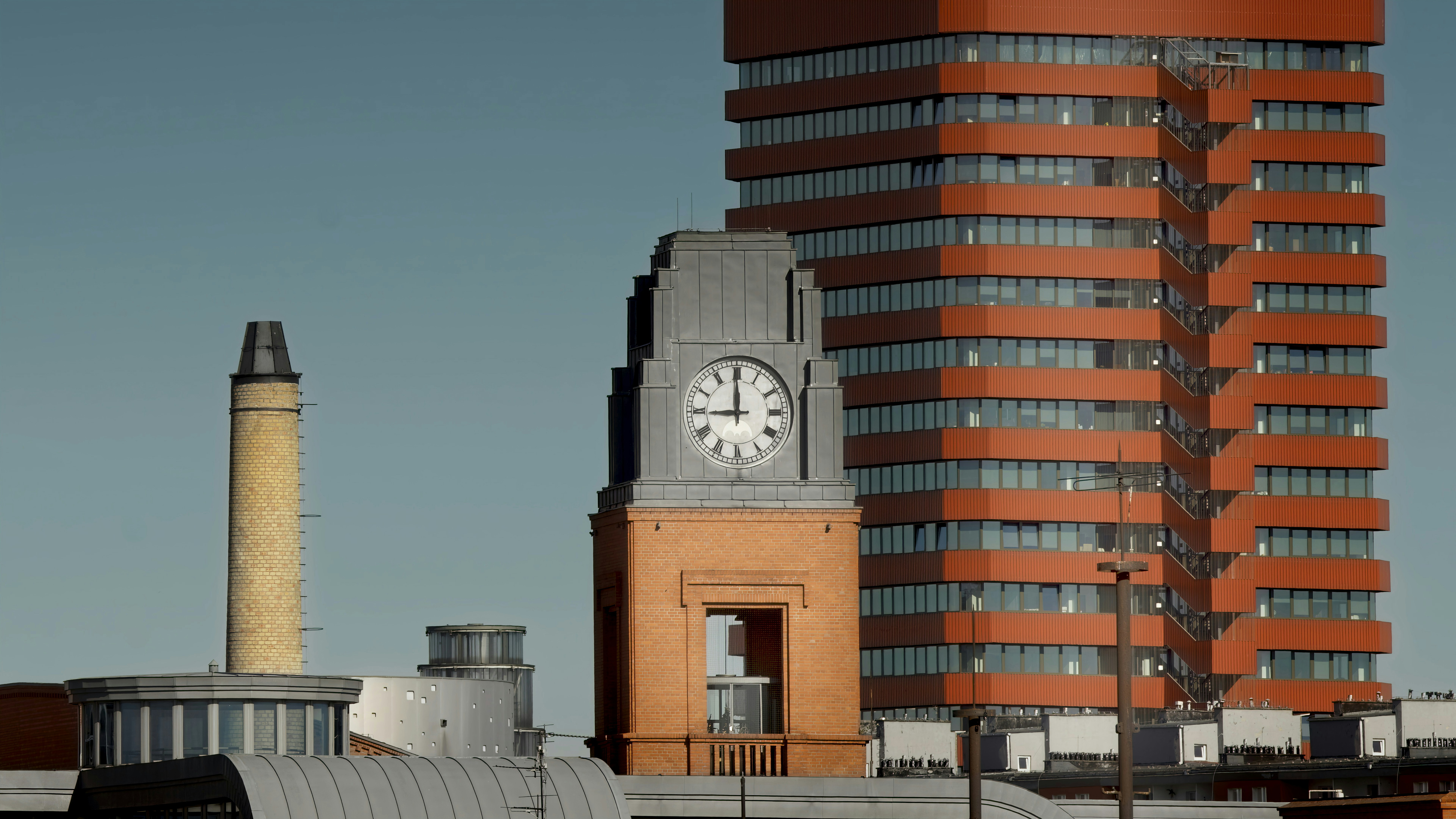 Clock tower with city buildings under a blue sky. photo – Free ...