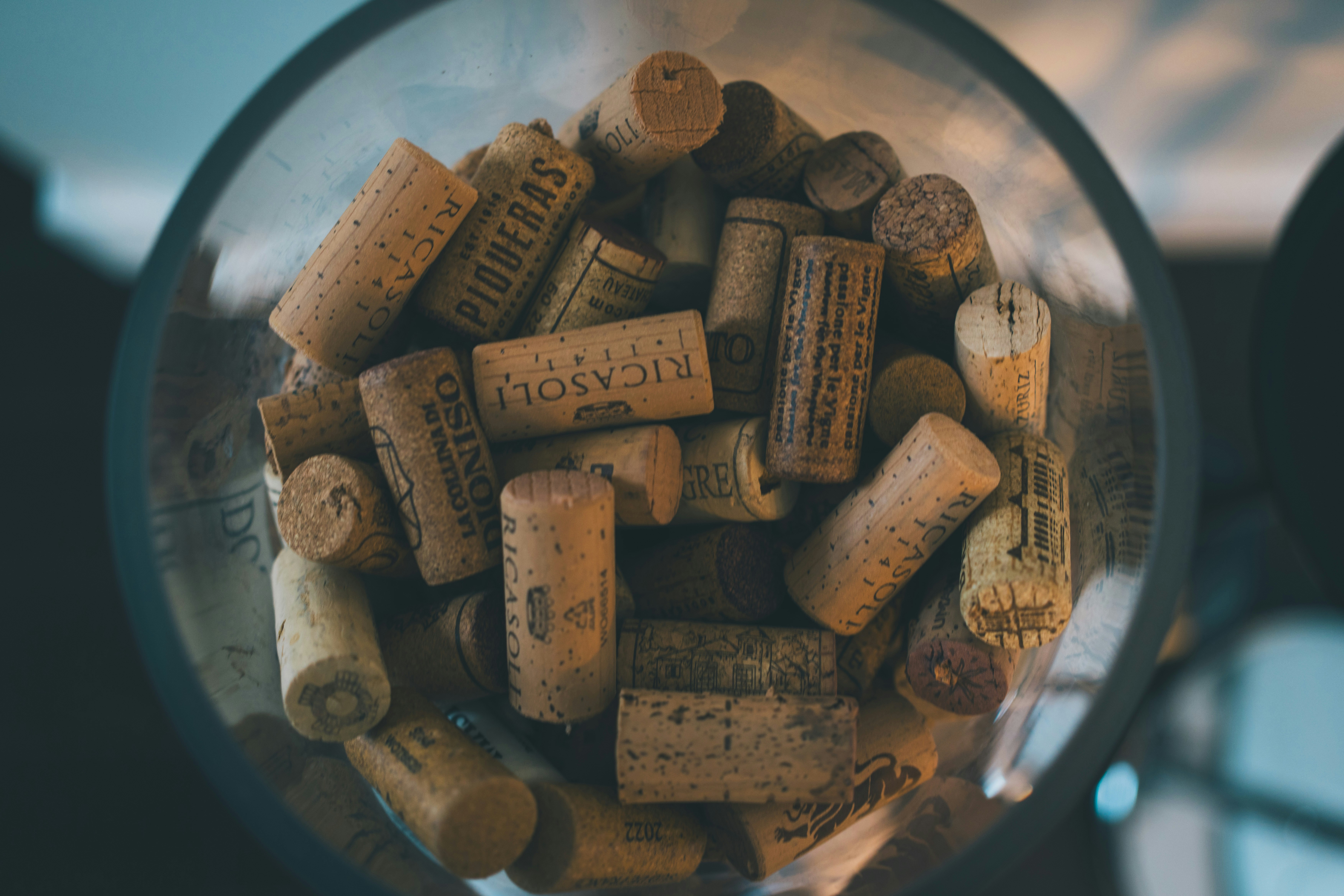 Wine corks fill a glass.