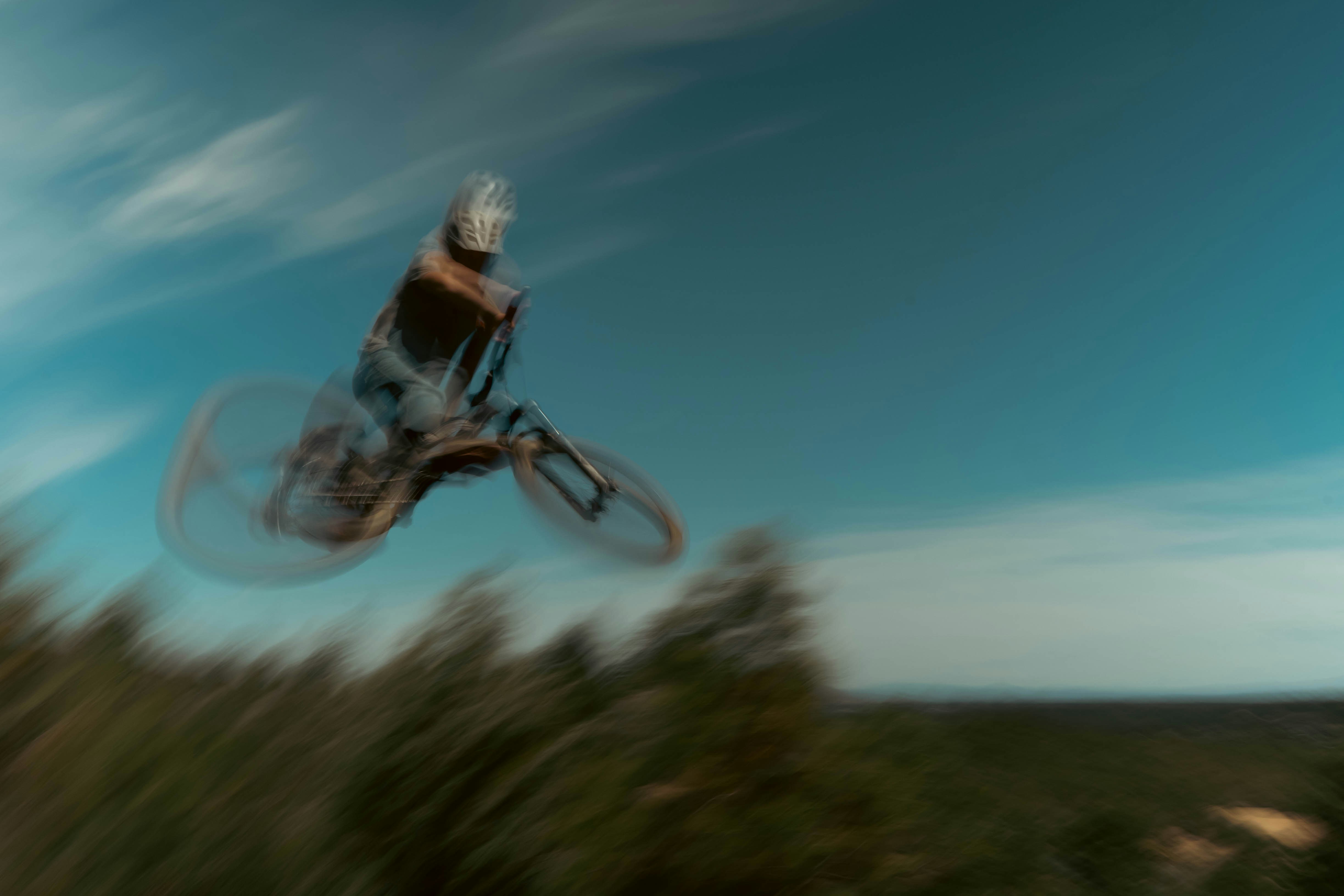 A cyclist performs a jump in mid-air. photo – Free Wallpaper Image on ...