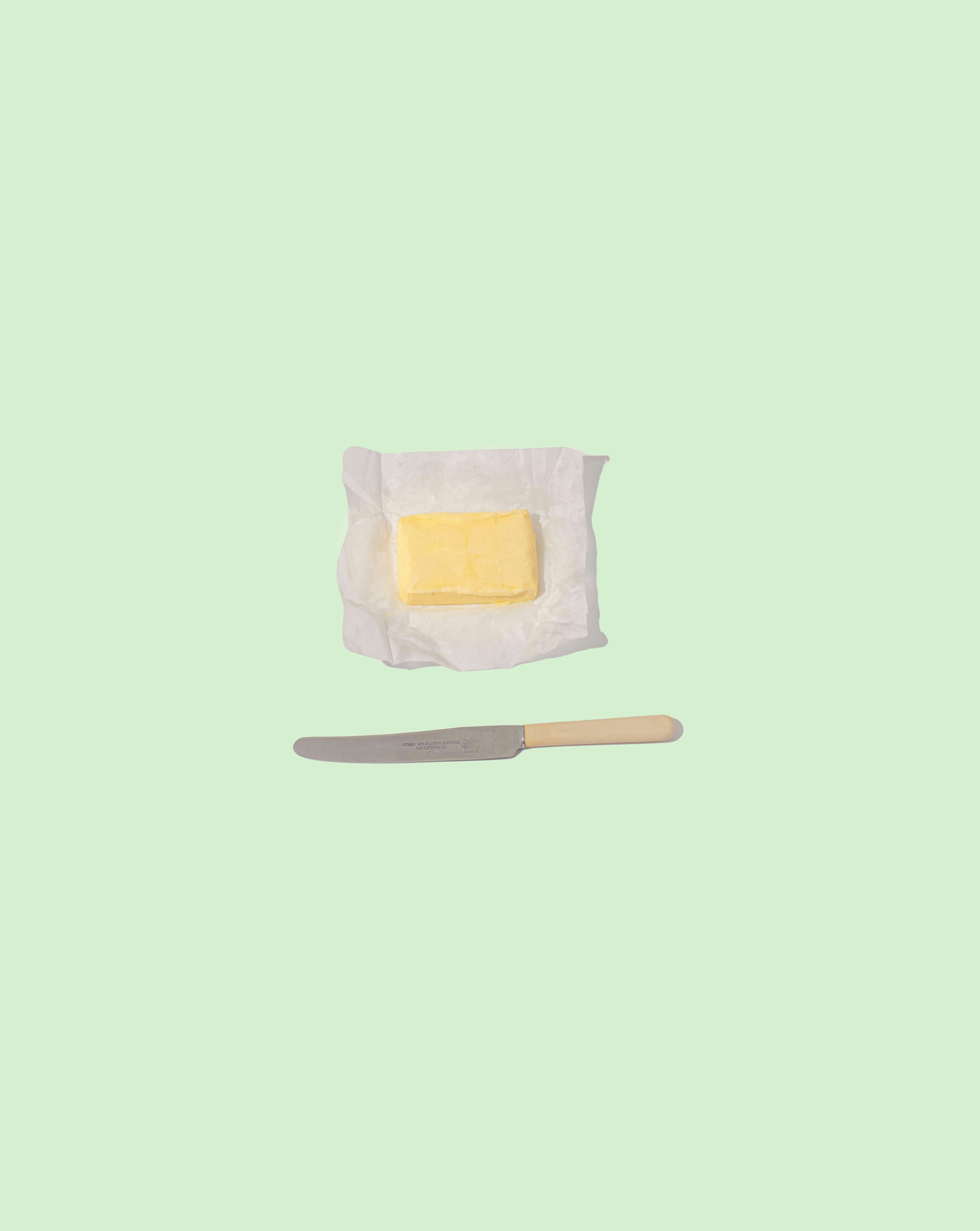 Butter and a knife are ready to be used.