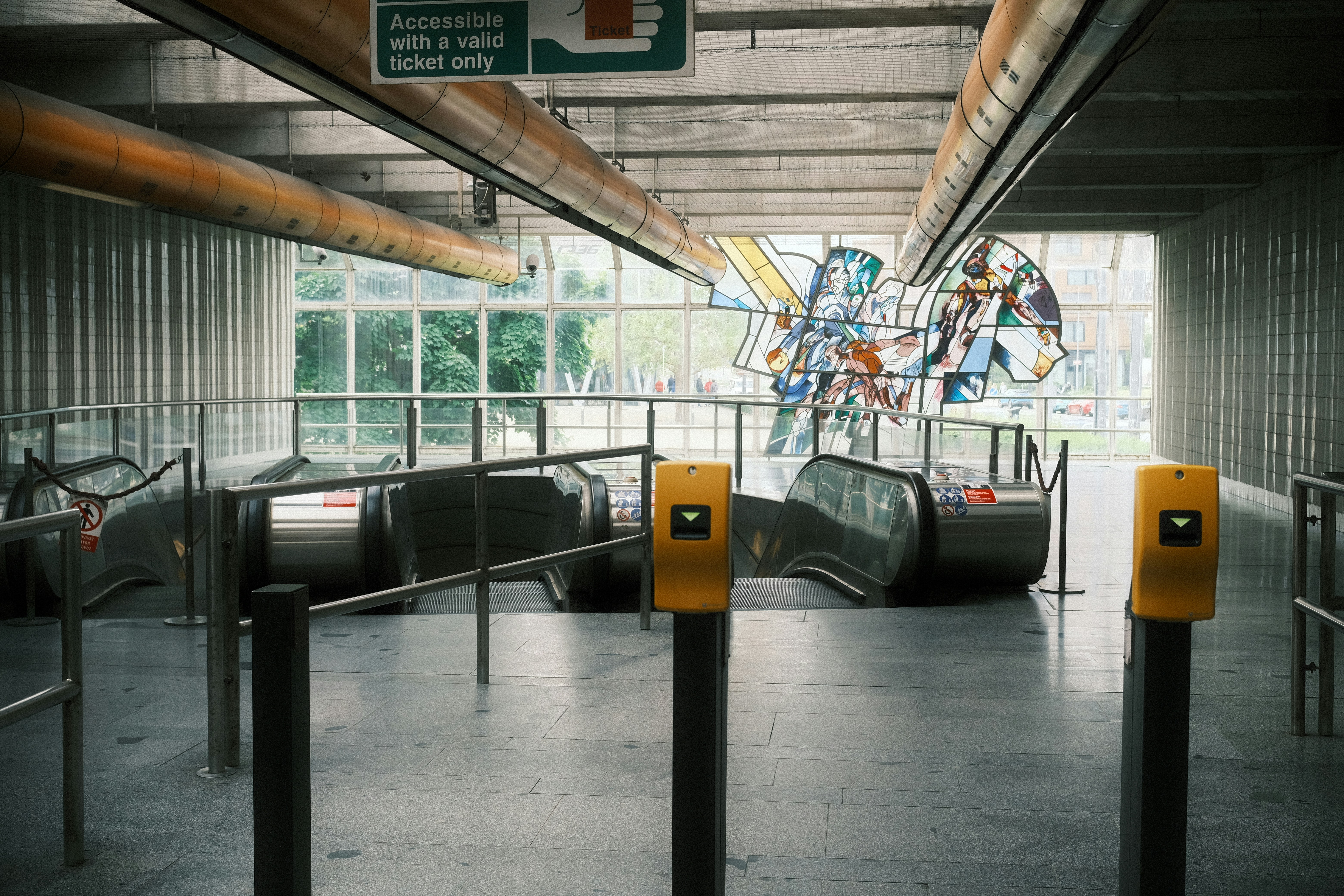 Transit Atrium: Escalators Framing a Graffiti Gallery