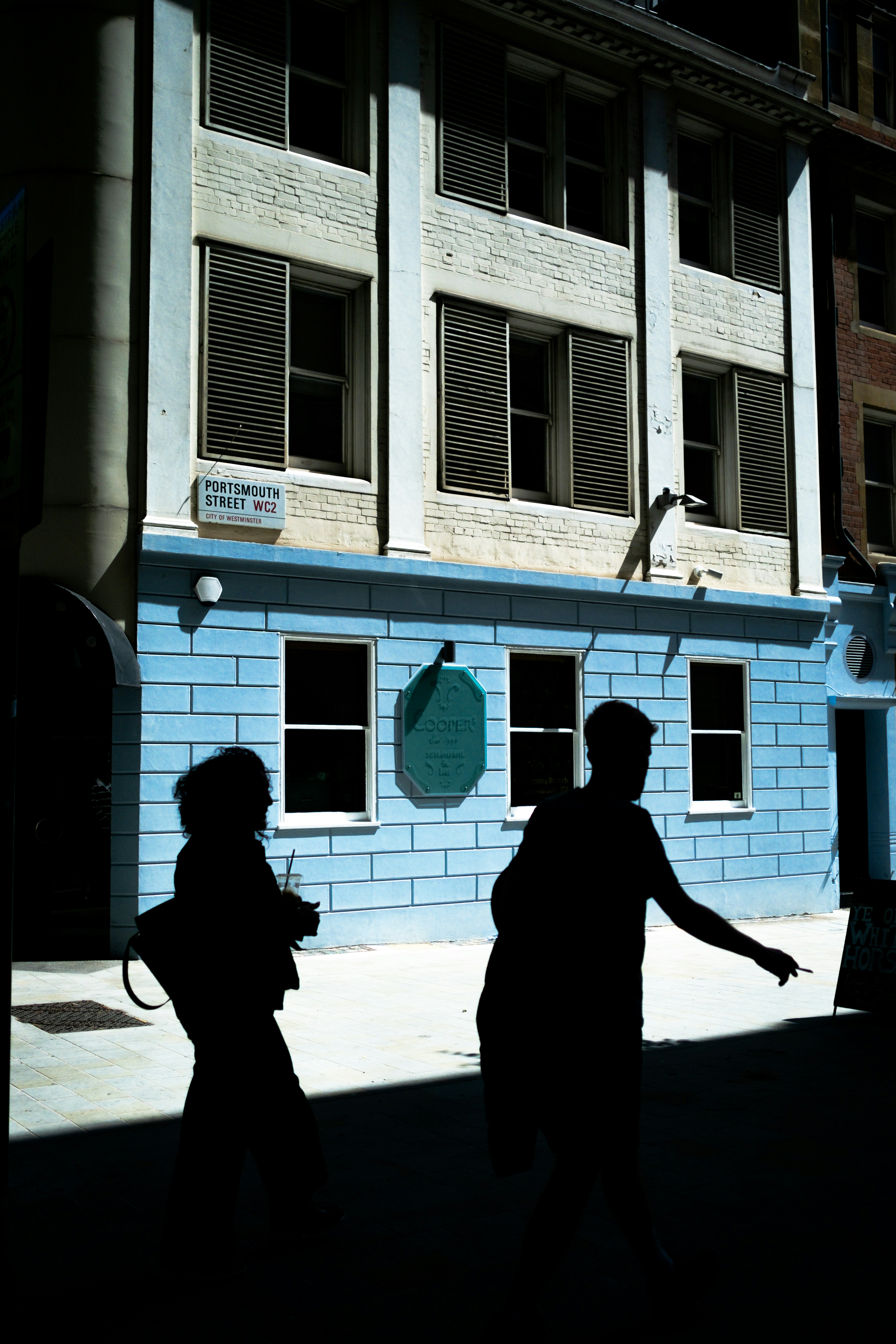 Teal Plaque on a Blue-Washed Facade: Shadows of Portsmouth Street