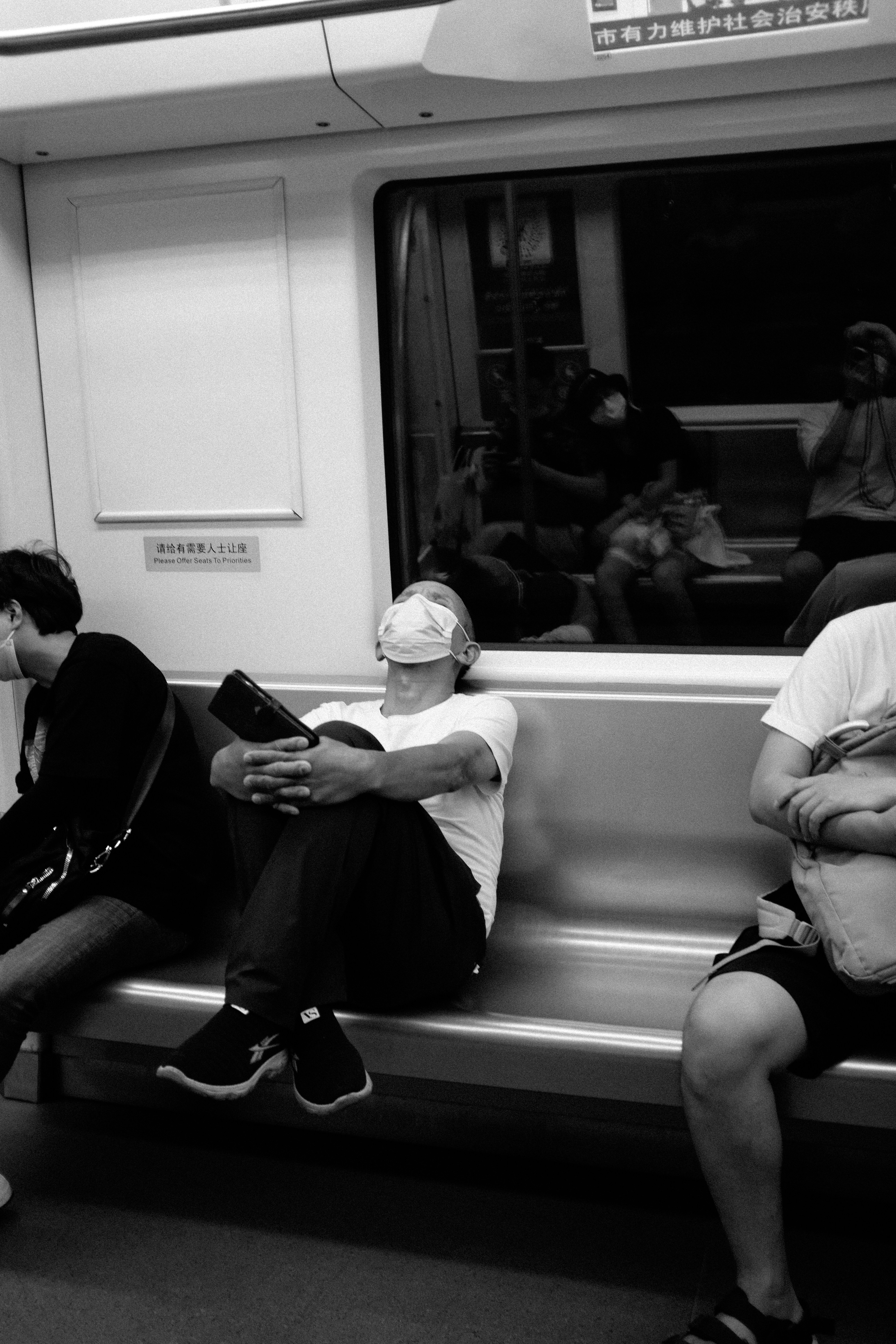 People ride on a train during a health crisis. photo – Free Rest Image ...