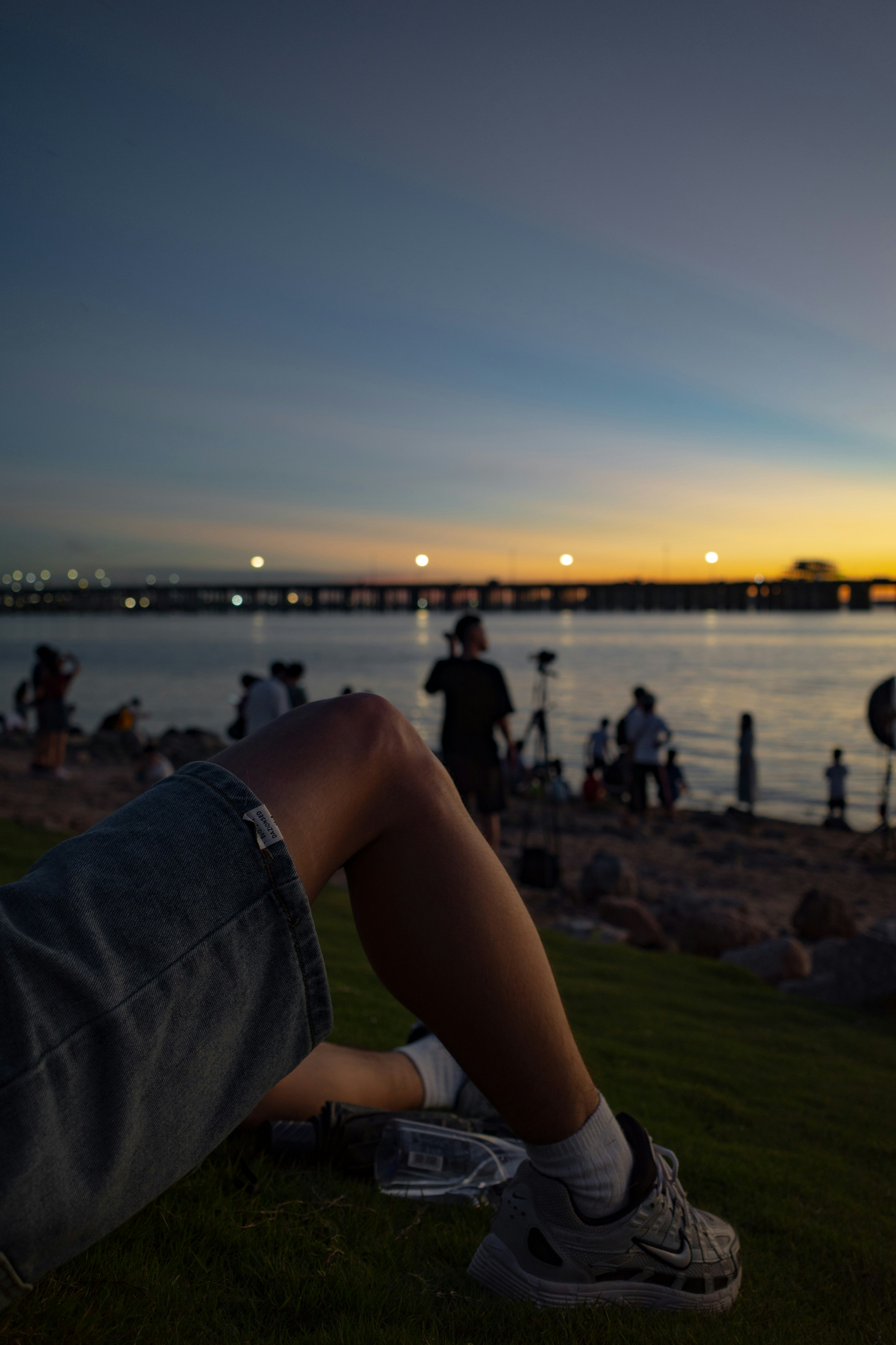 Grounded at Dusk: A Foreground Leg Framing the Sunset Pier
