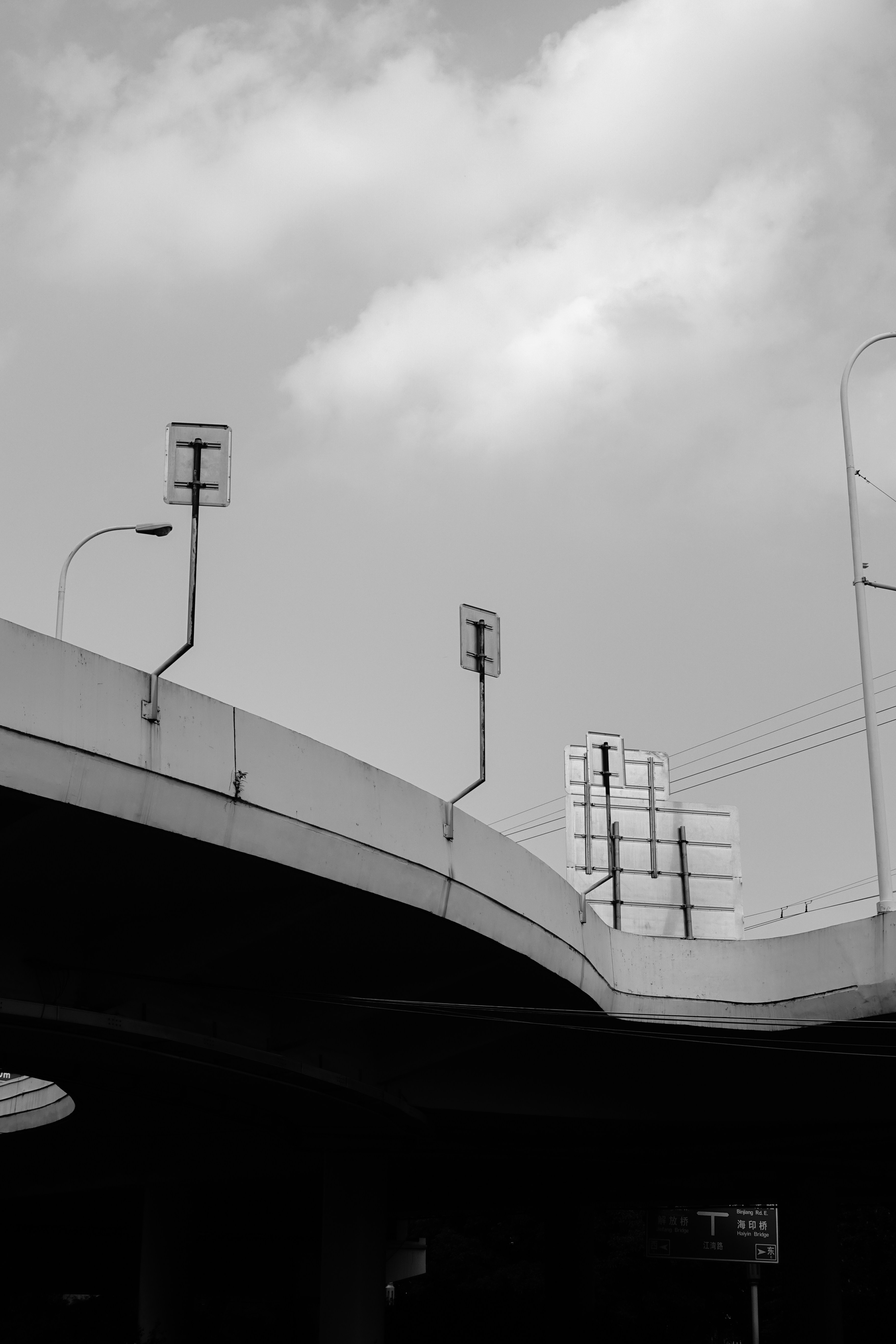 Overpass structure with road signs against cloudy sky. photo – Free ...