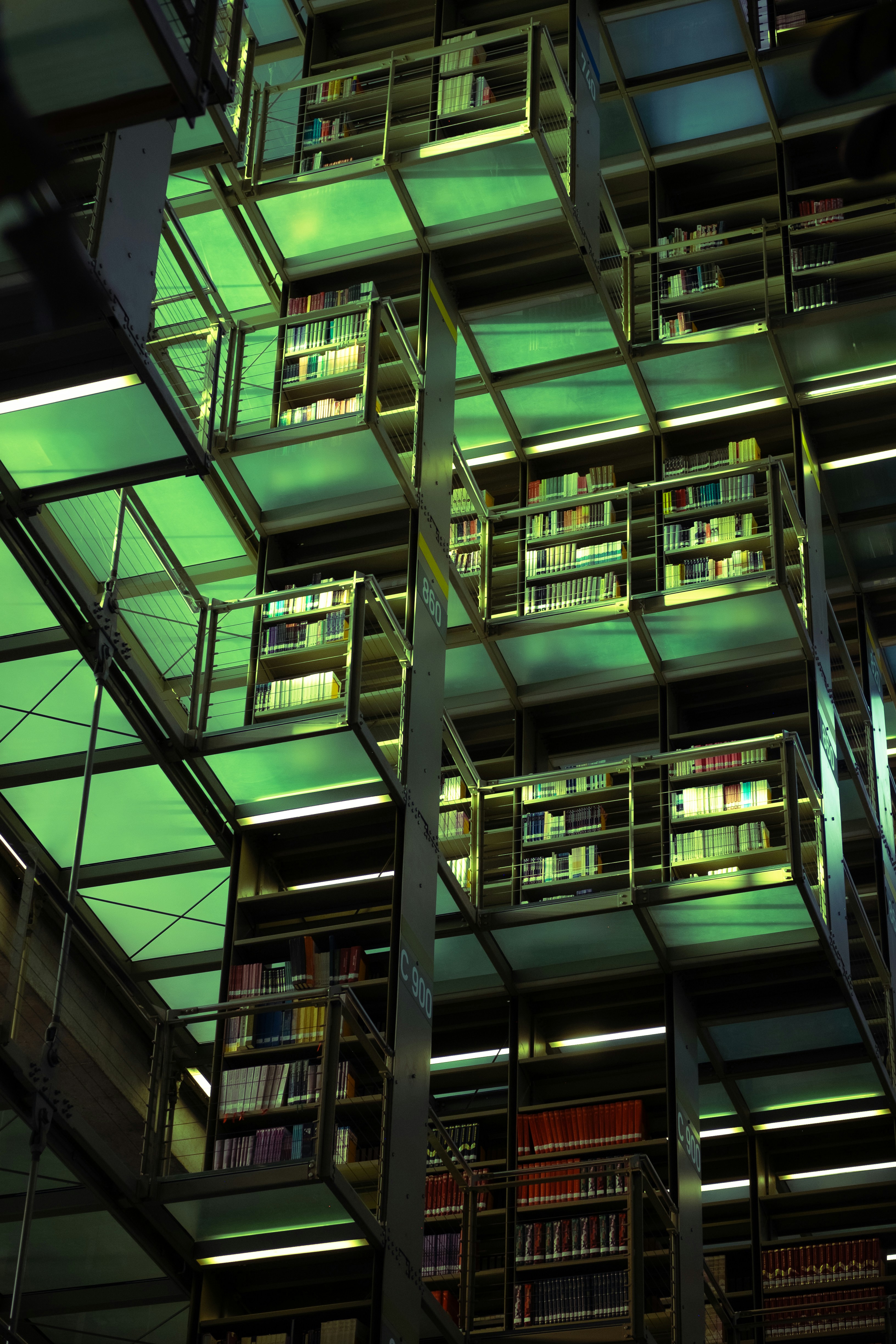 Bookshelves are stacked in an architecturally interesting library ...