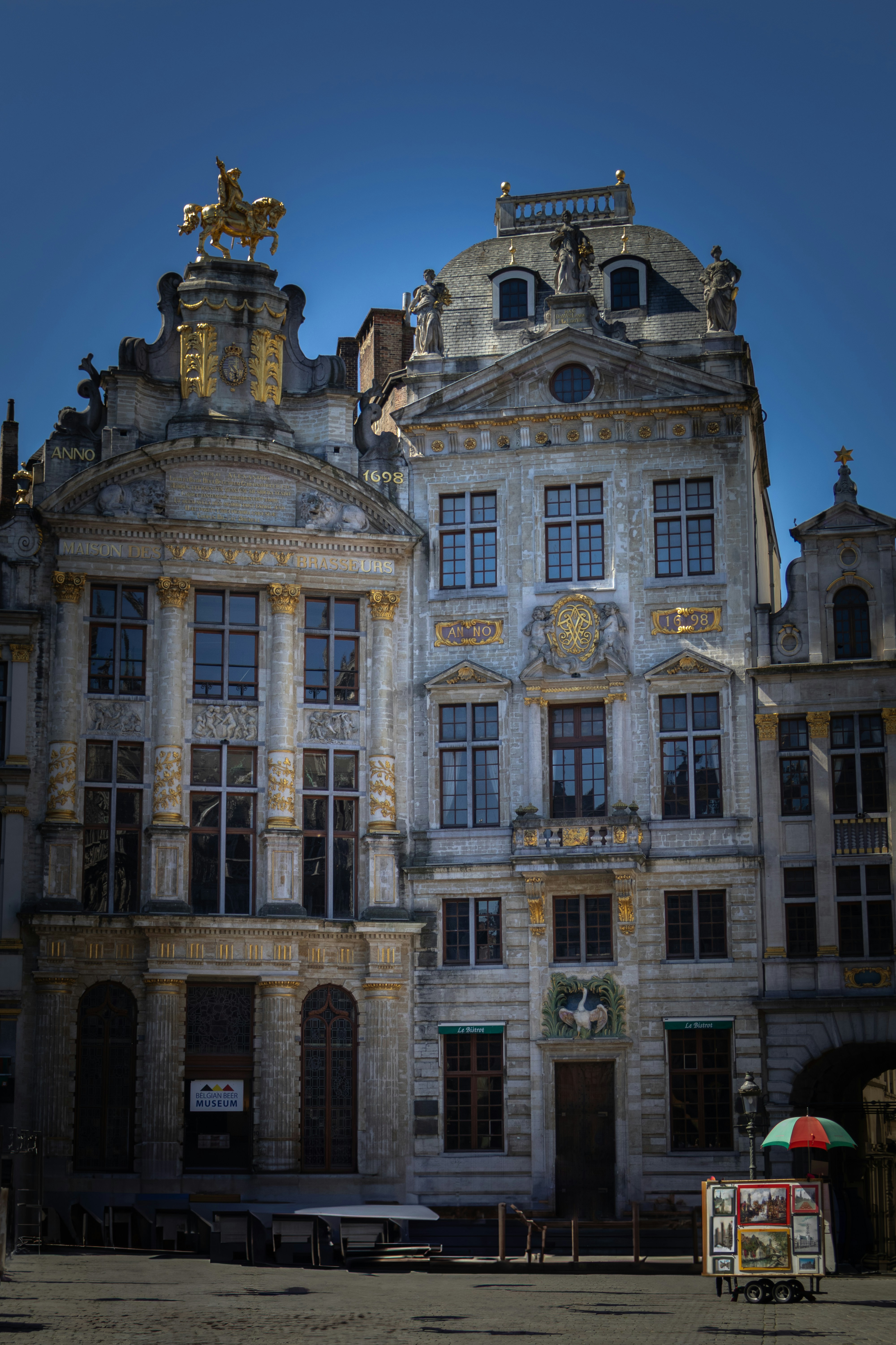 Gold-Trimmed Giants Beneath a Clear Azure: A Flemish Renaissance Facade