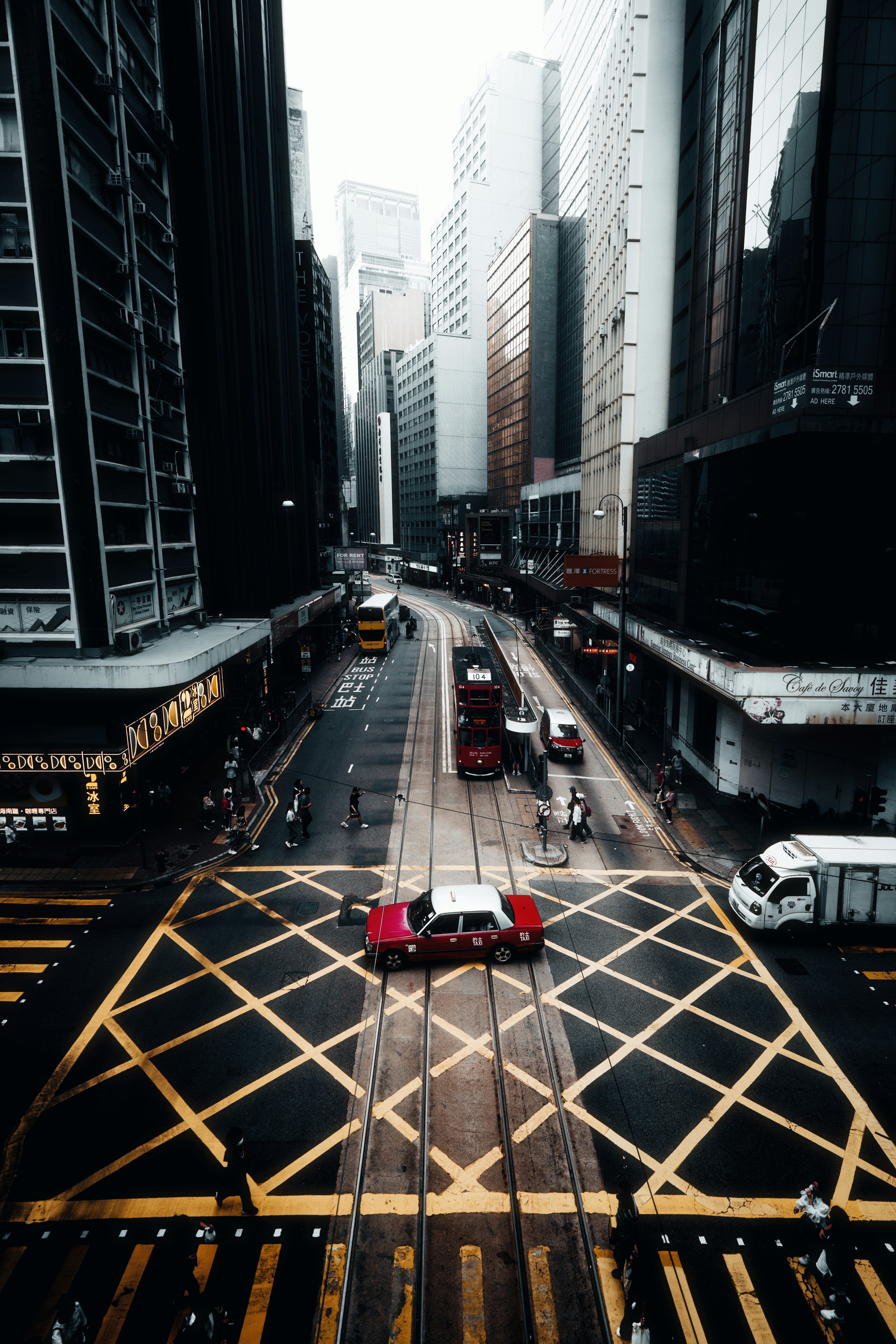 A red taxi navigates a busy city street. photo – Free Street ...