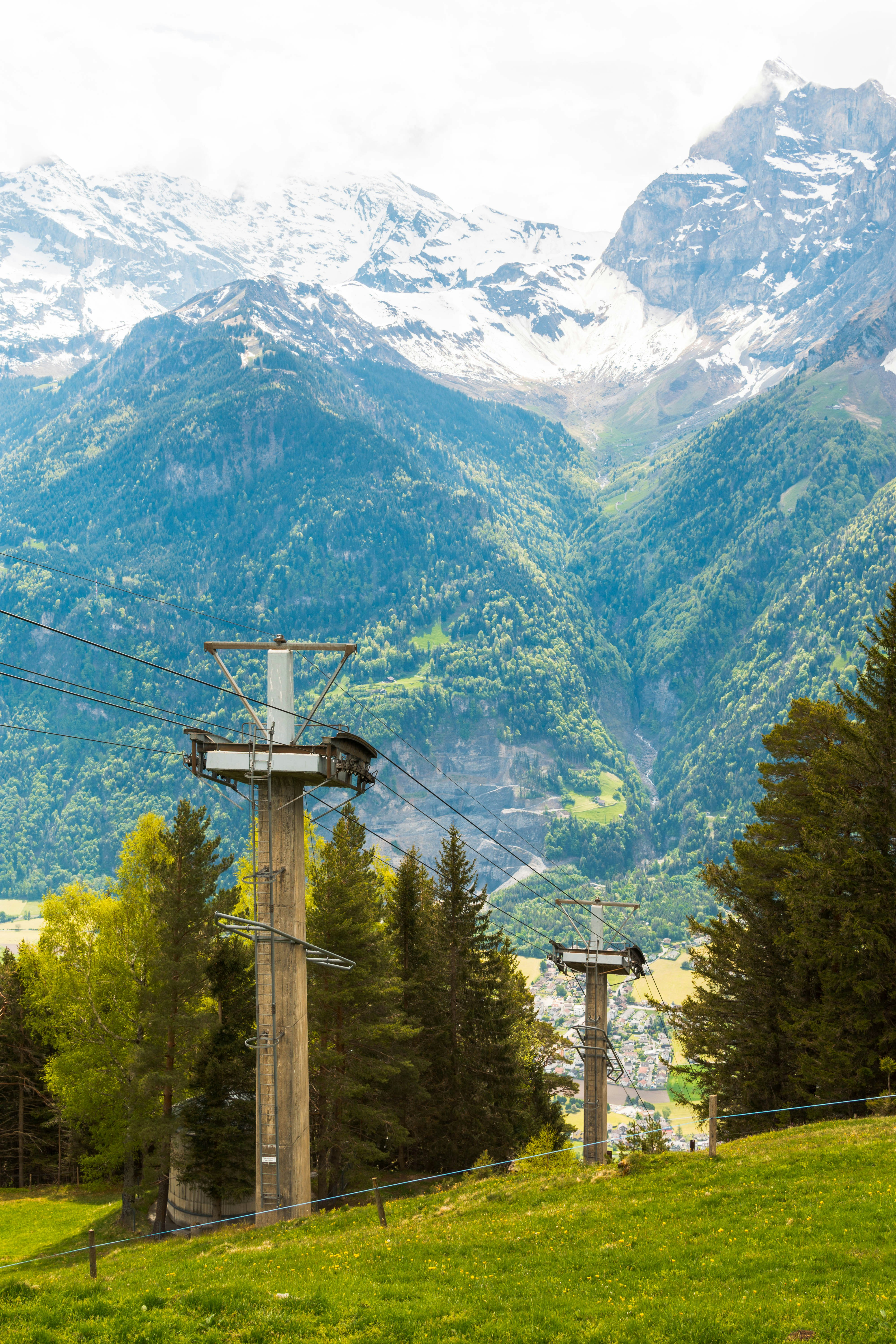 Cable Car Lines Through Alpine Valleys Beneath Snow-Capped Peaks