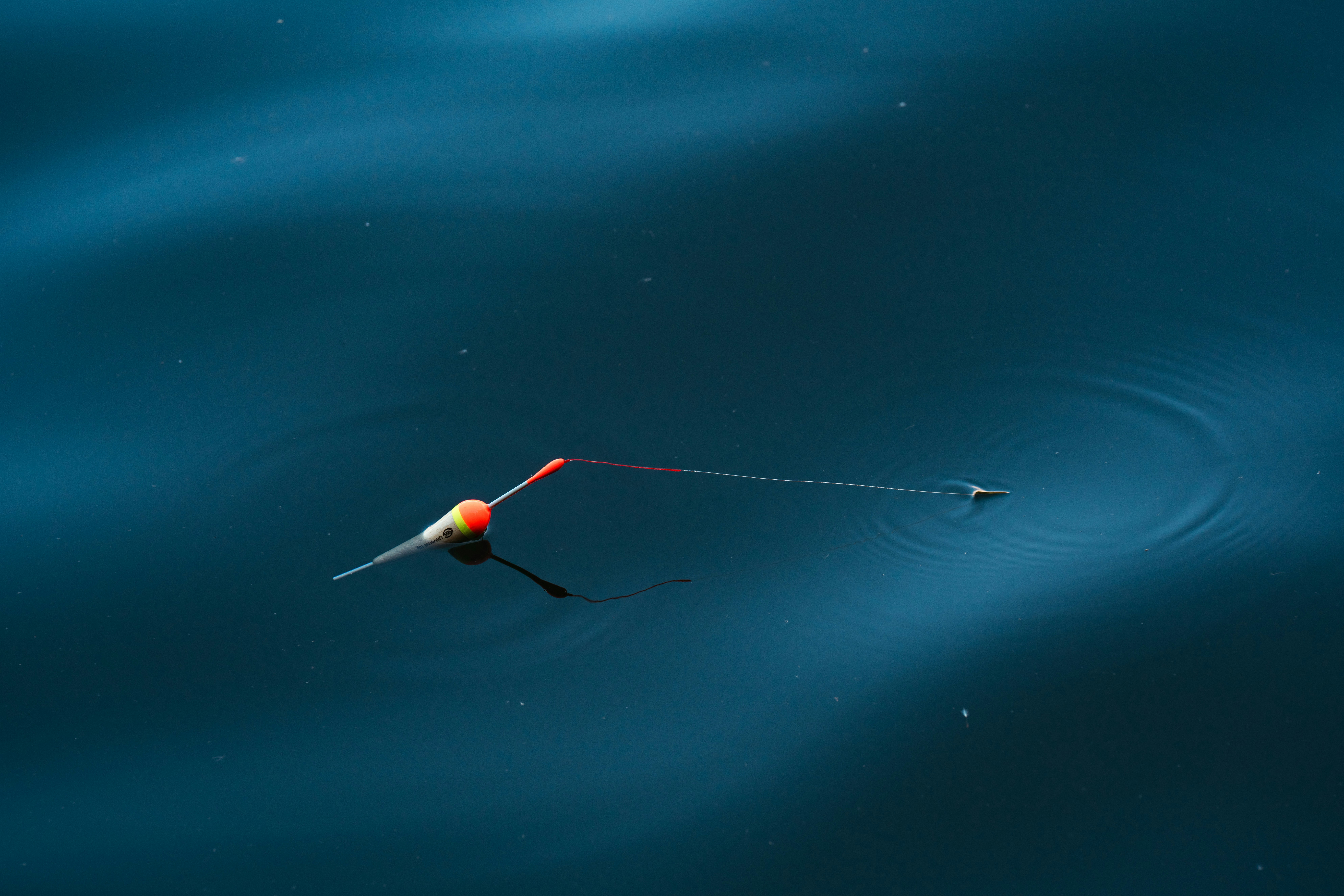 Crimson Beacon Drifting Across Velvet Blue Waters
