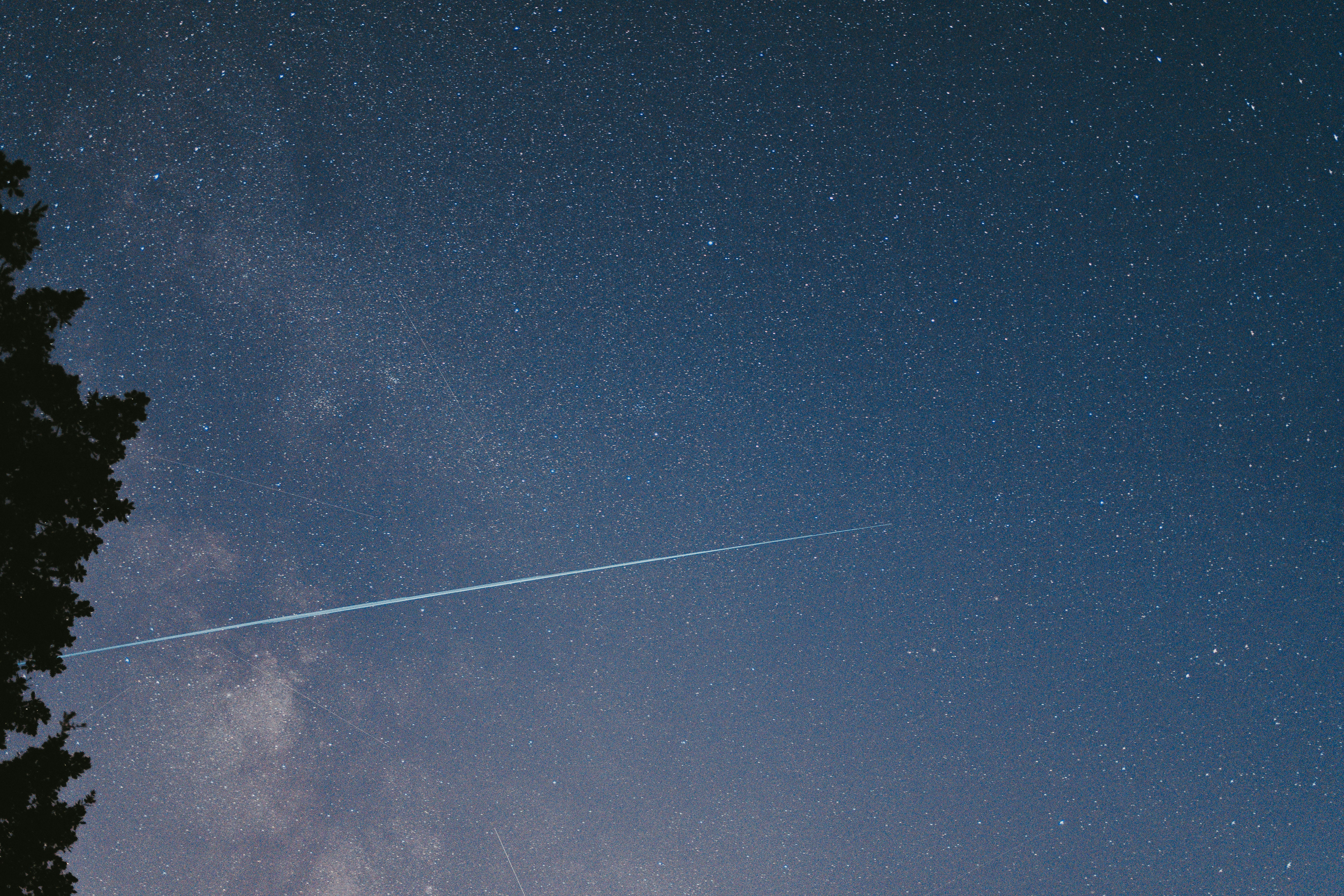 Celestial Whispers: A Streak of Light in the Night Sky