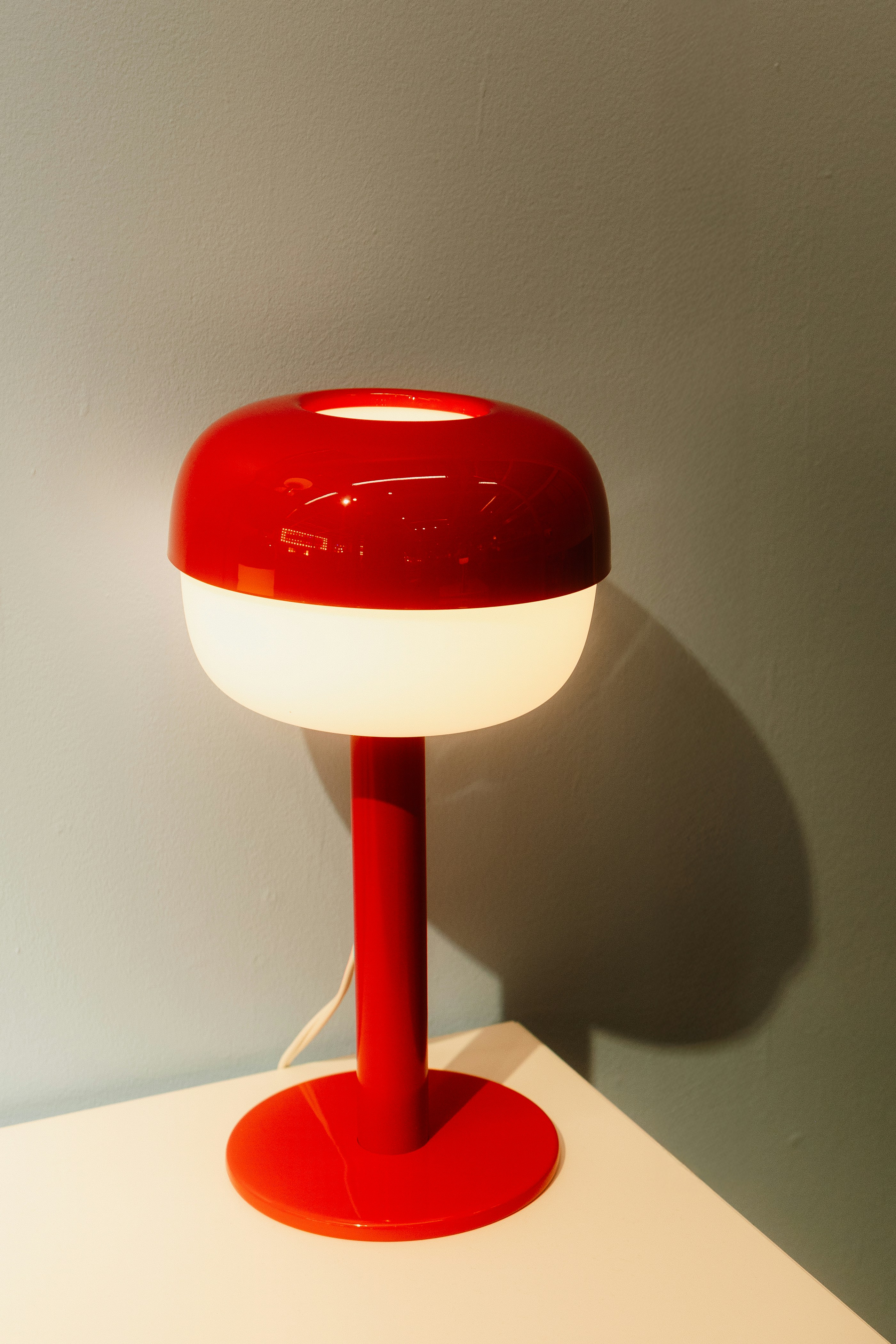 Crimson Dome Lamp on a Quiet White Desk