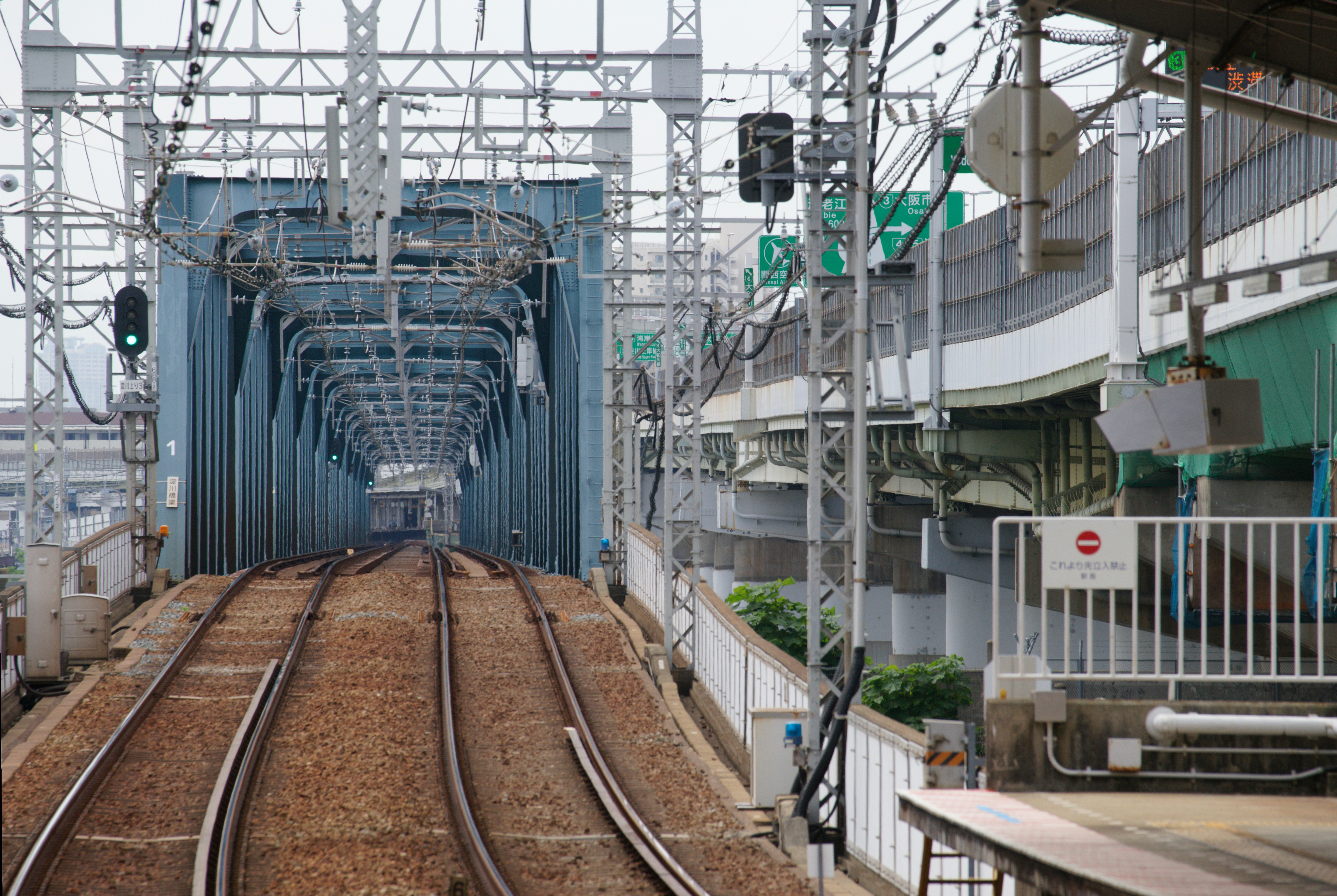 Train tracks lead into a covered structure.
