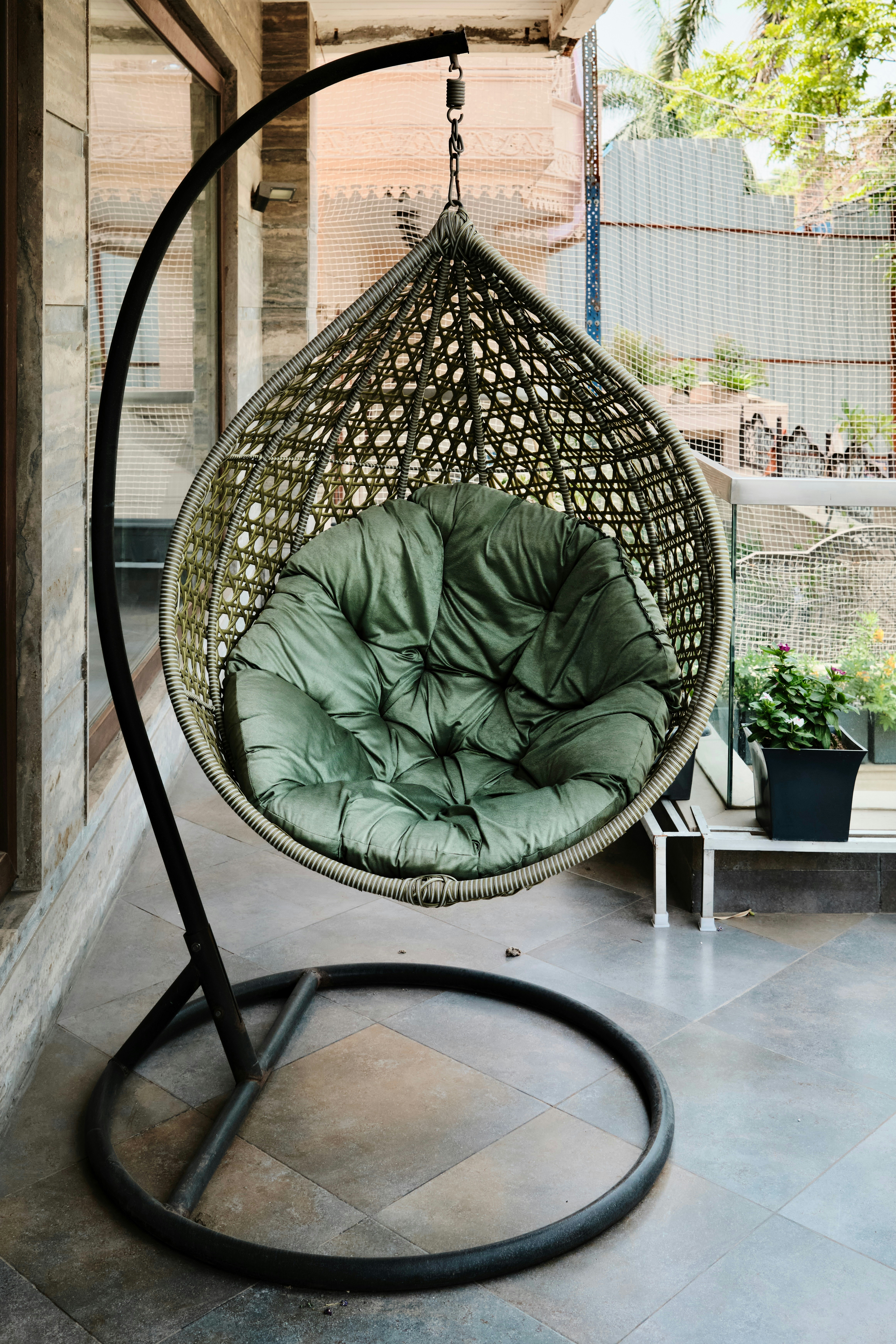Teal Cushioned Nest on a Balcony Swing
