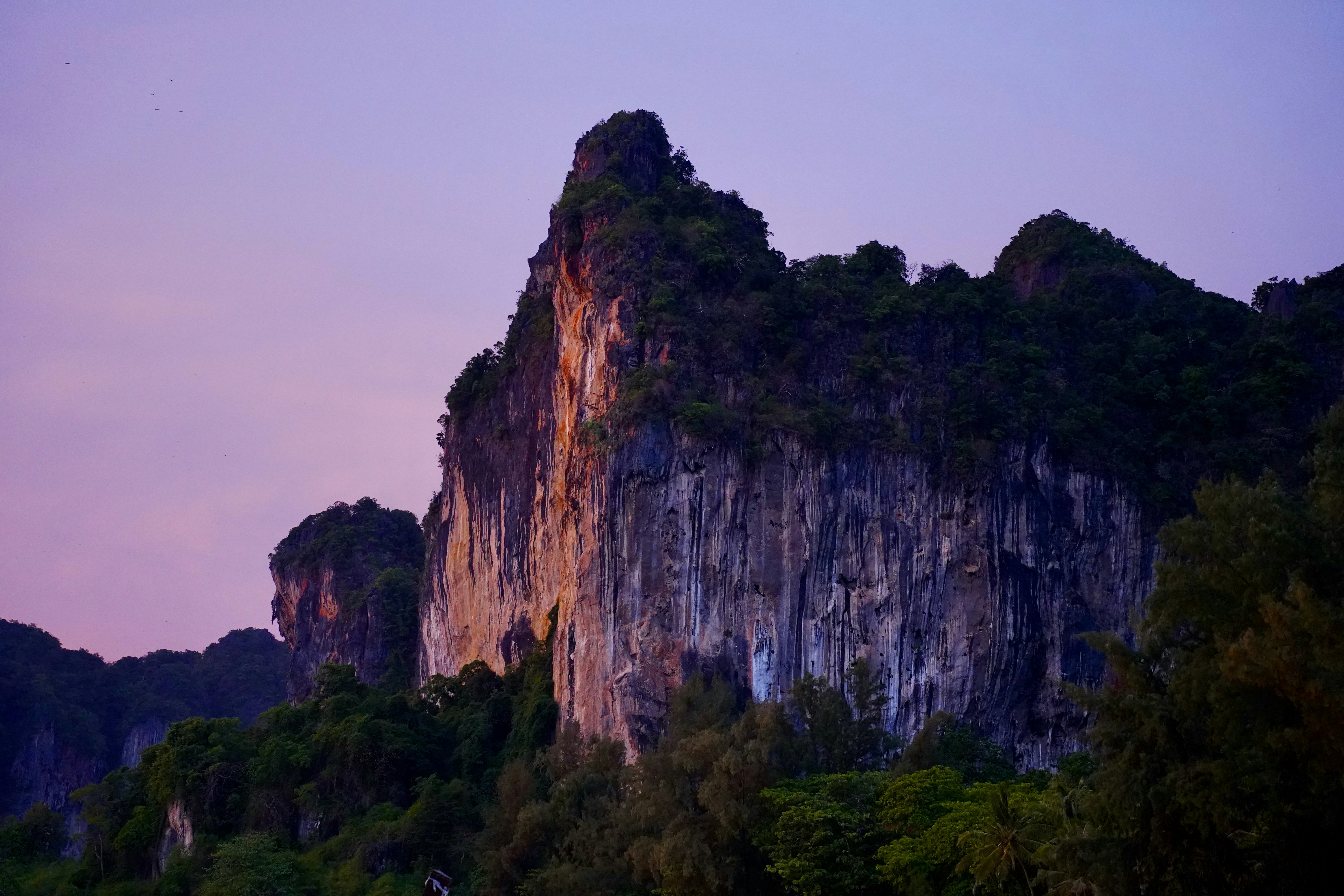 A majestic cliff under a pink and purple sky. photo – Free Forest Image ...