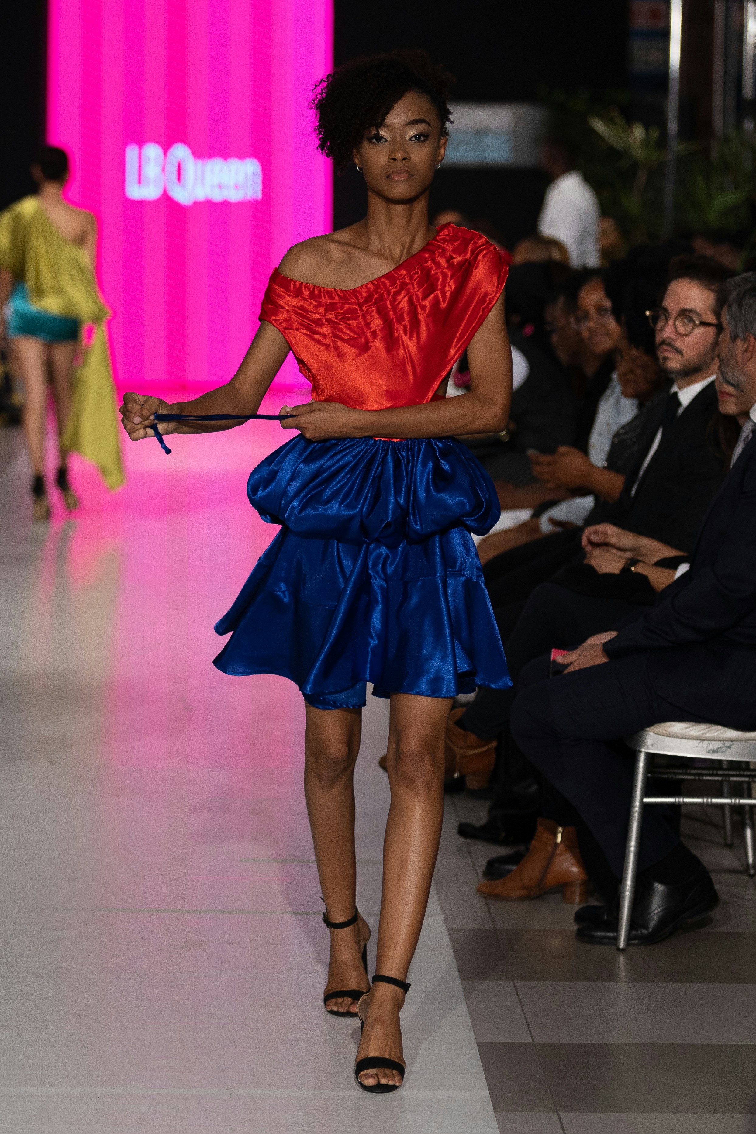 Crimson Off-Shoulder Meets Indigo Ruffles on a Neon Runway