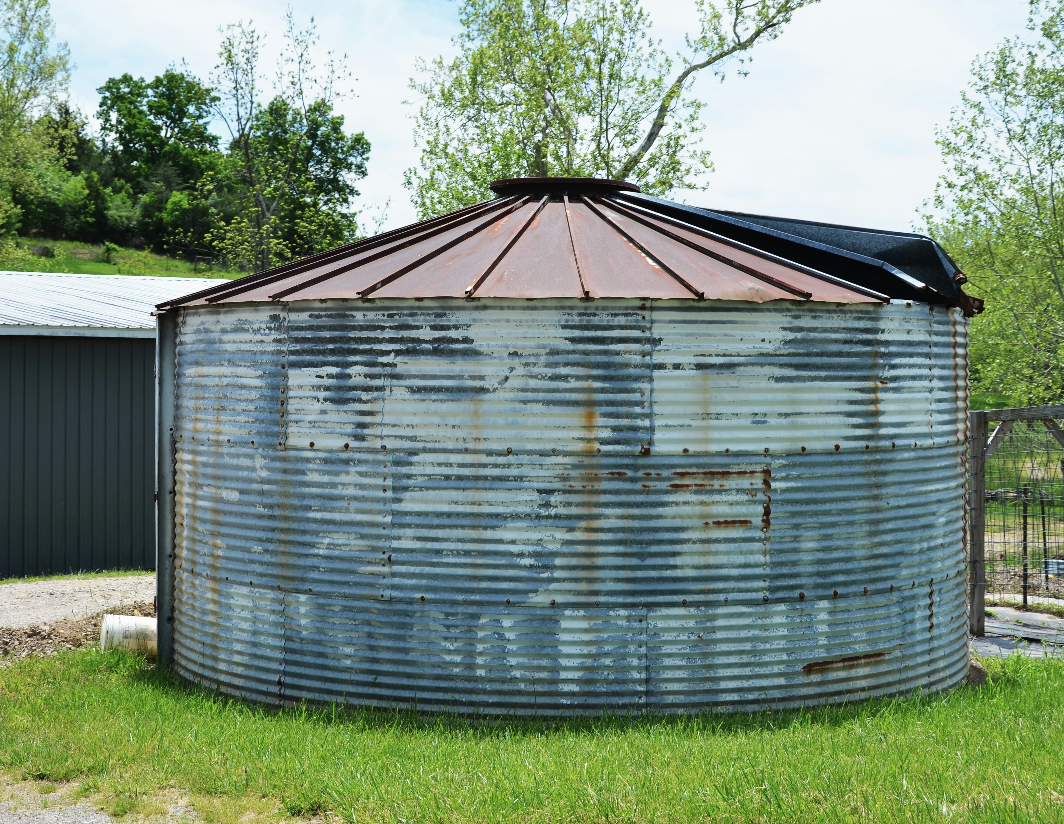A rundown, rustic silo is seen outdoors. photo – Free Outdoors Image on ...