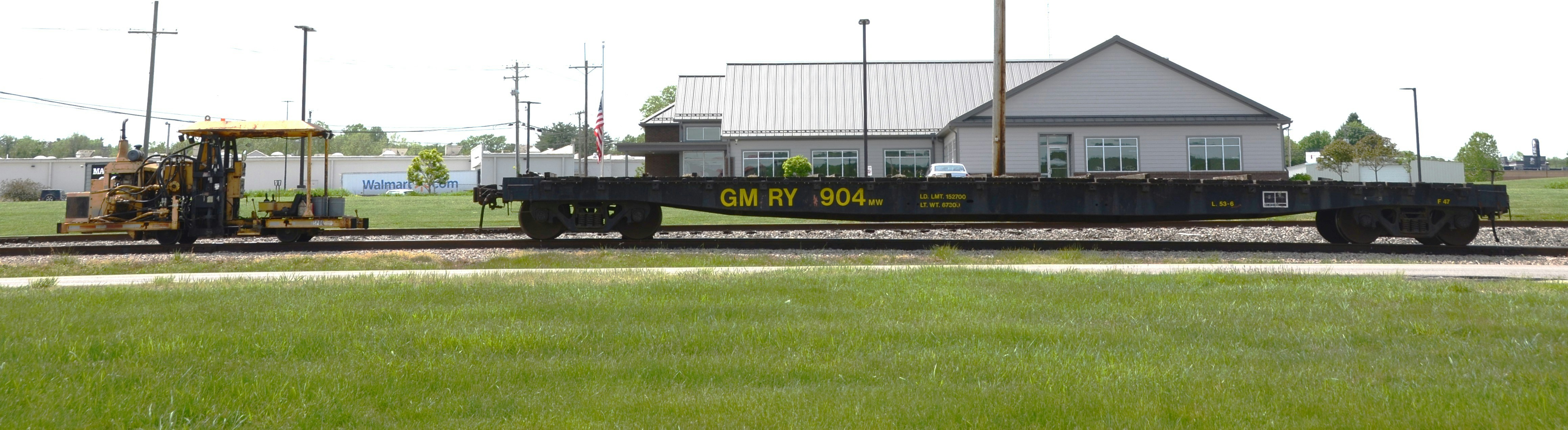 Train cars and machinery sit on railroad tracks. photo – Free Car Image ...