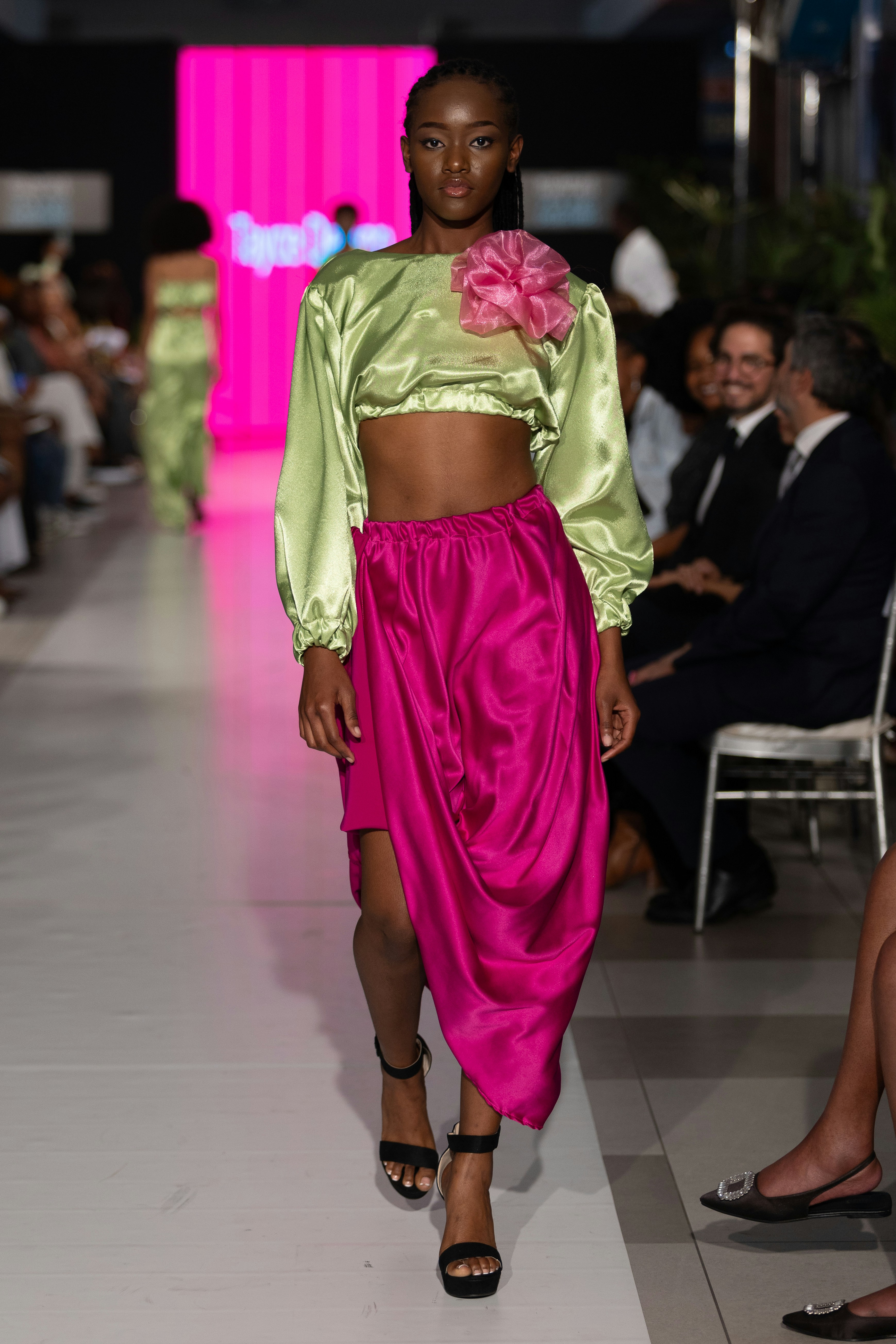 A model struts down the runway in bright colors. photo – Free Fashion ...