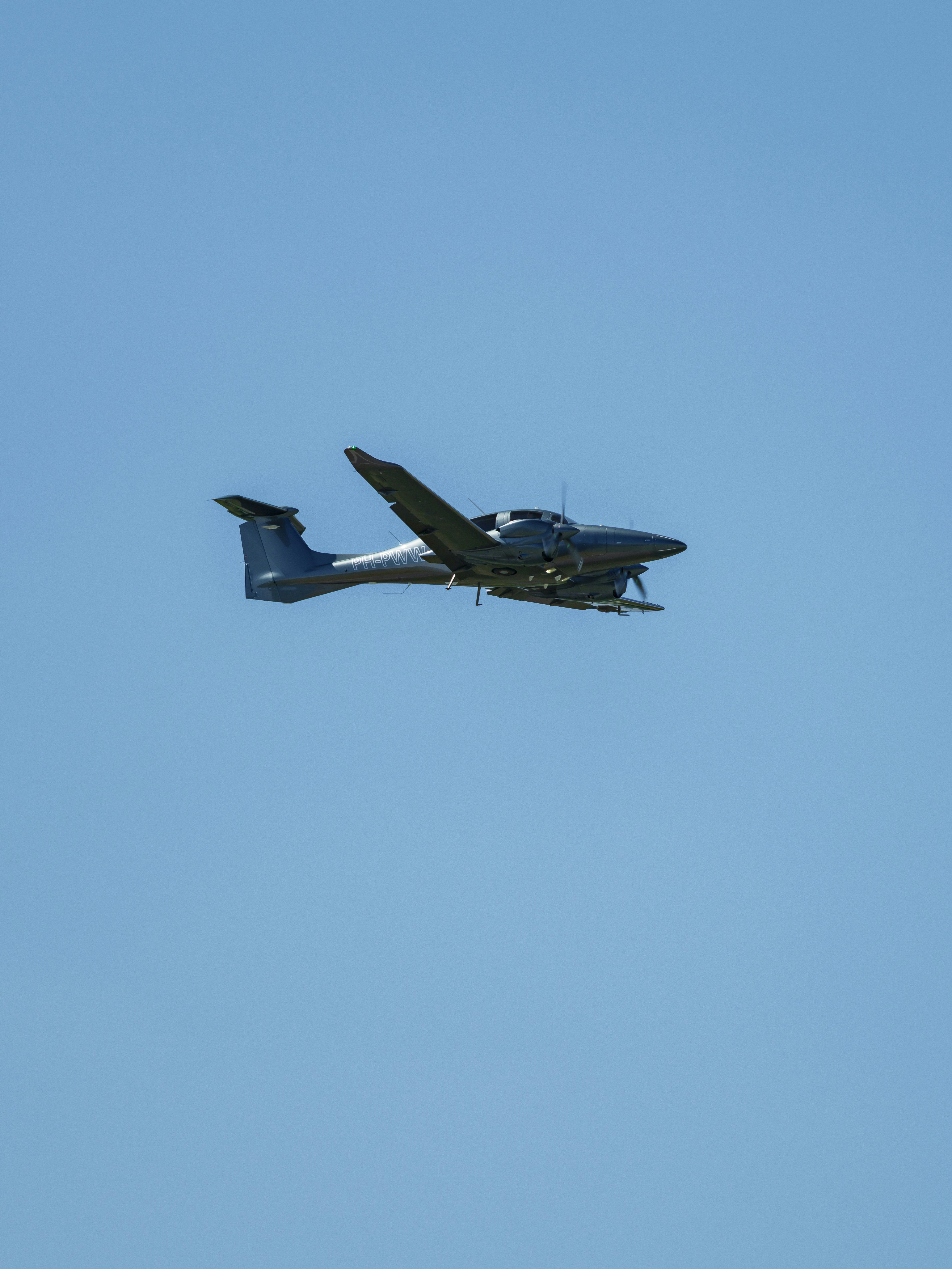 Light aircraft flying against a clear blue sky, showcasing the elegance of flight.