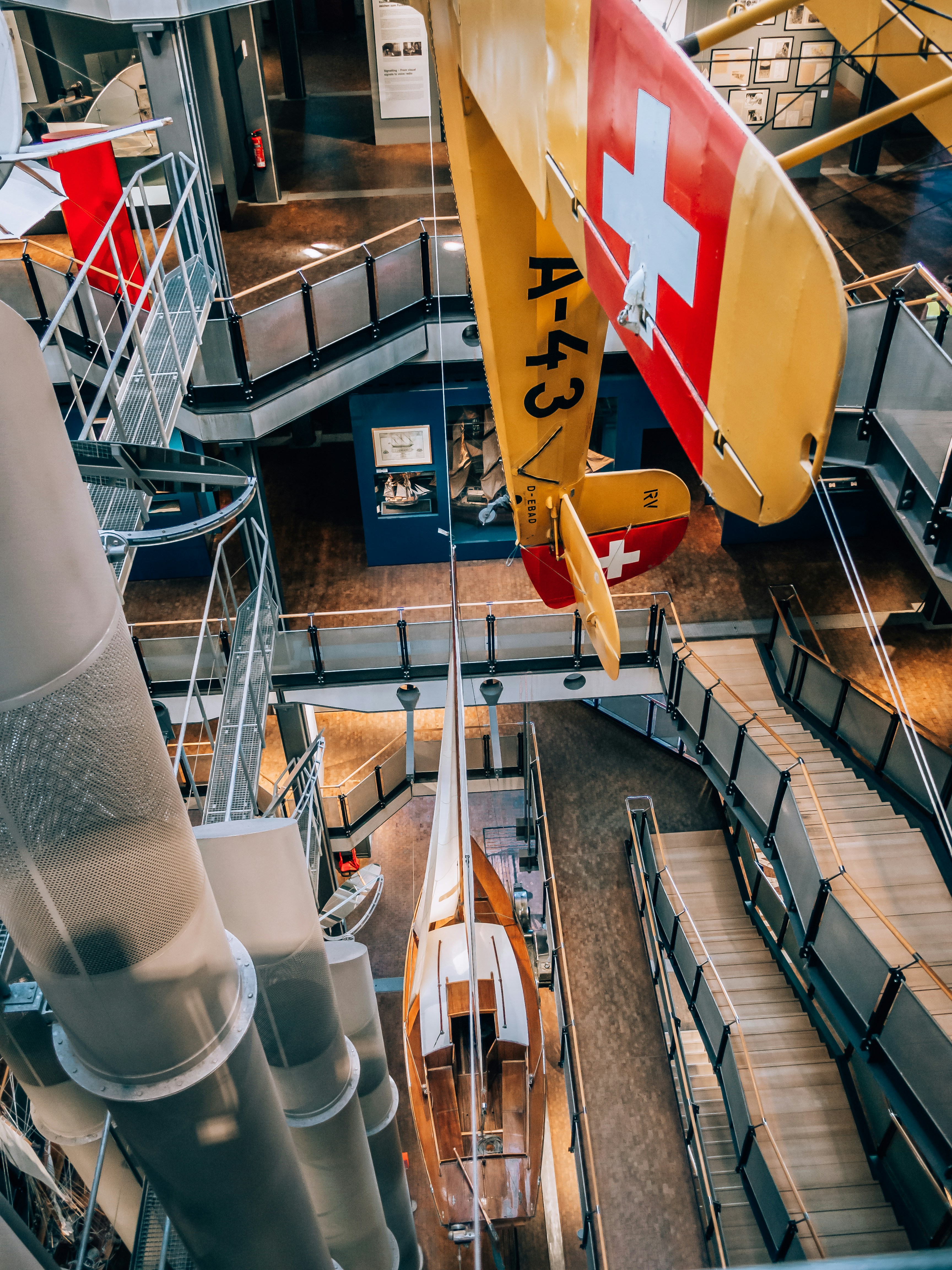 Atrium of Flying Flags: Suspended Aircraft and Staircase Ballet