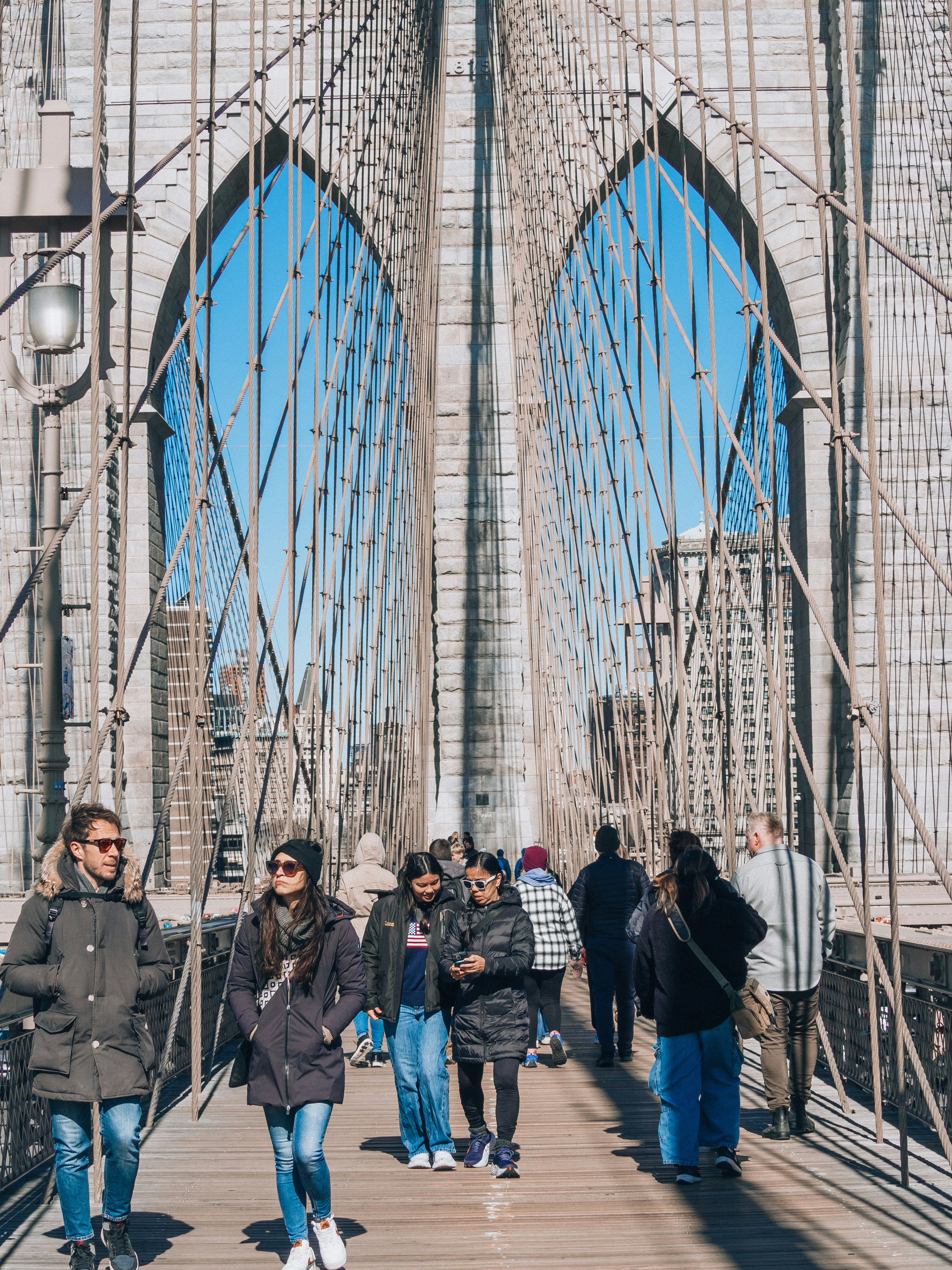 Pedestrians Cross a Neon-Sky Bridge