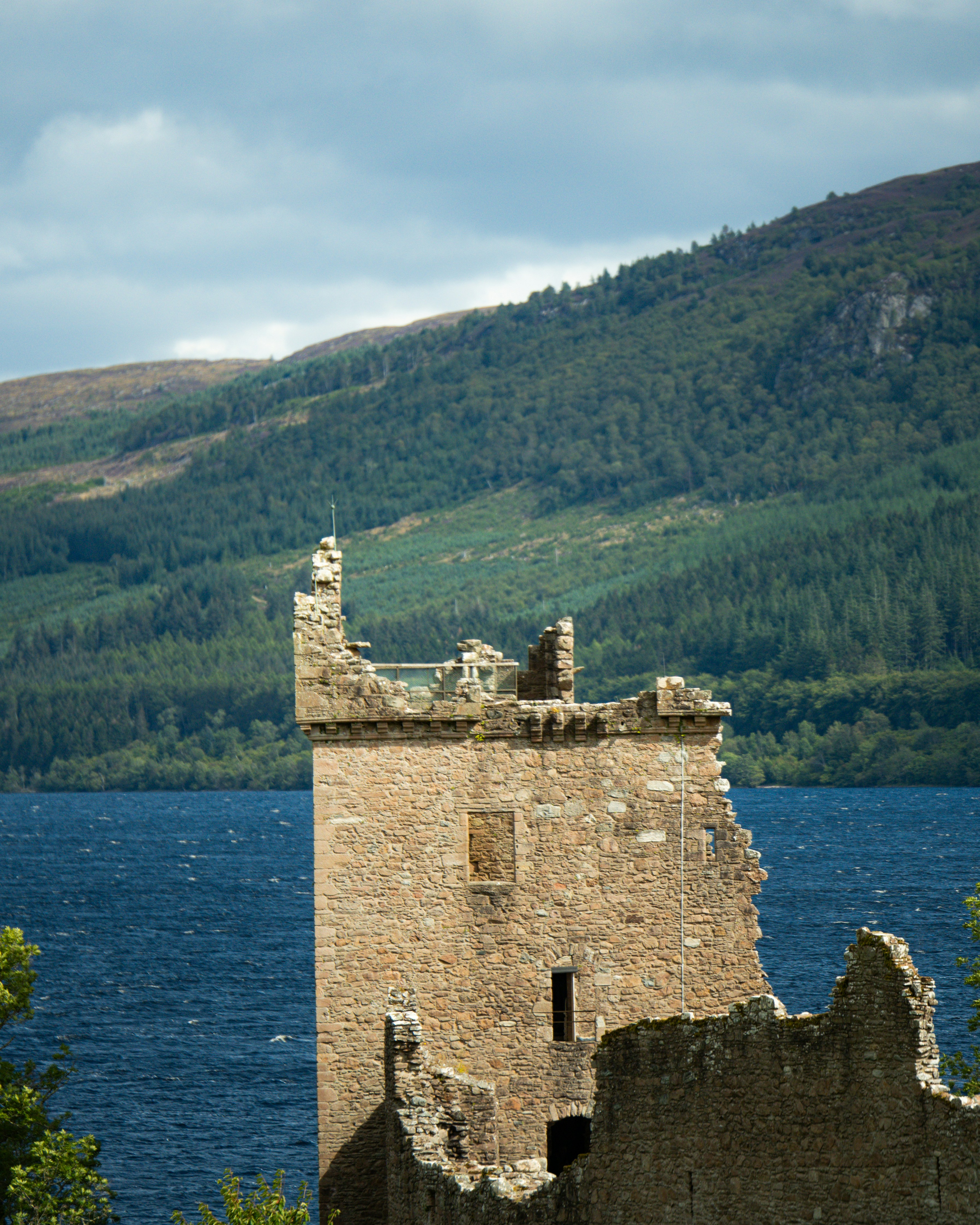 Stone Sentinel by the Lake: A Ruined Tower Over Quiet Waters