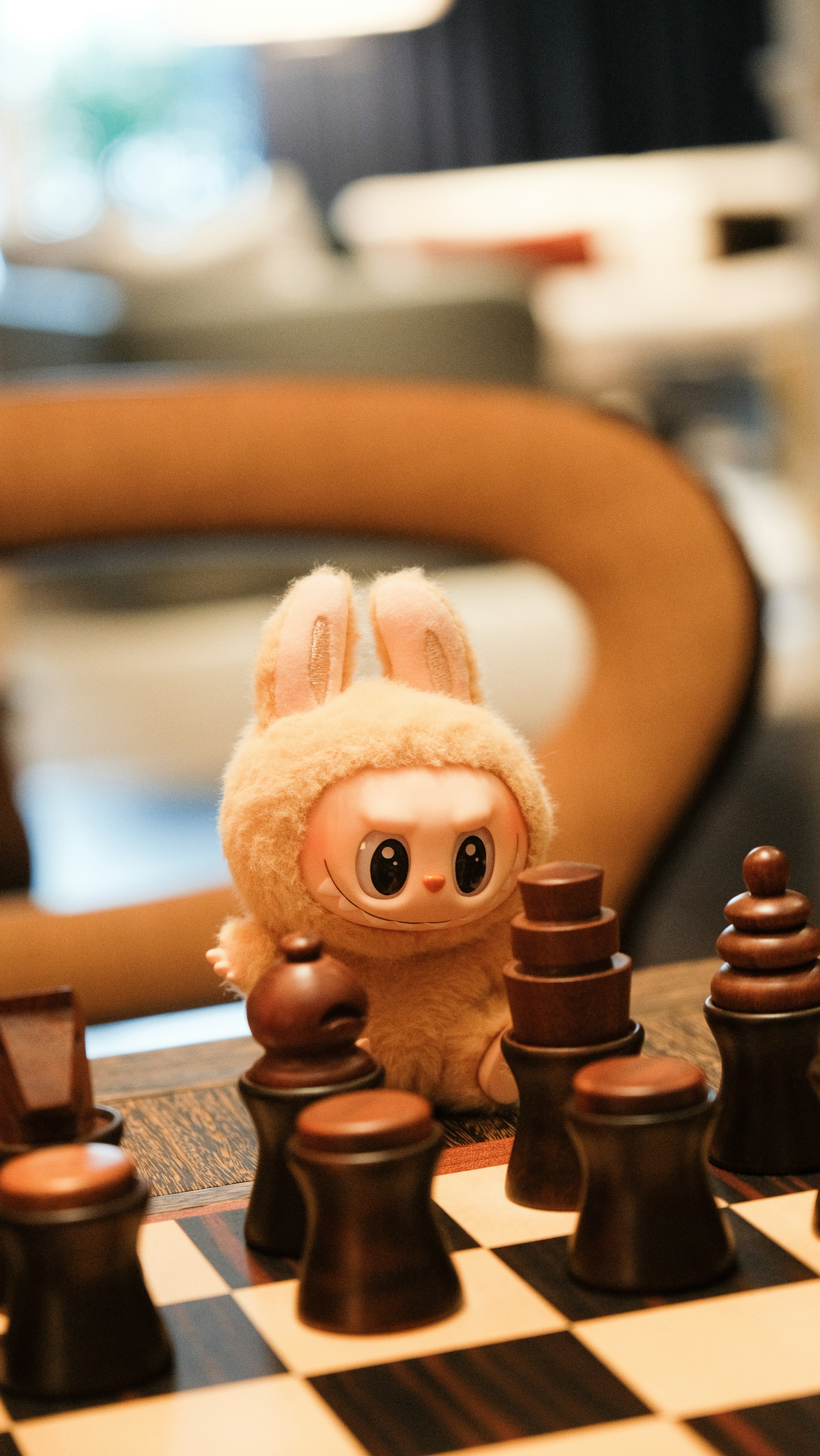 A rabbit toy watches a chess match.