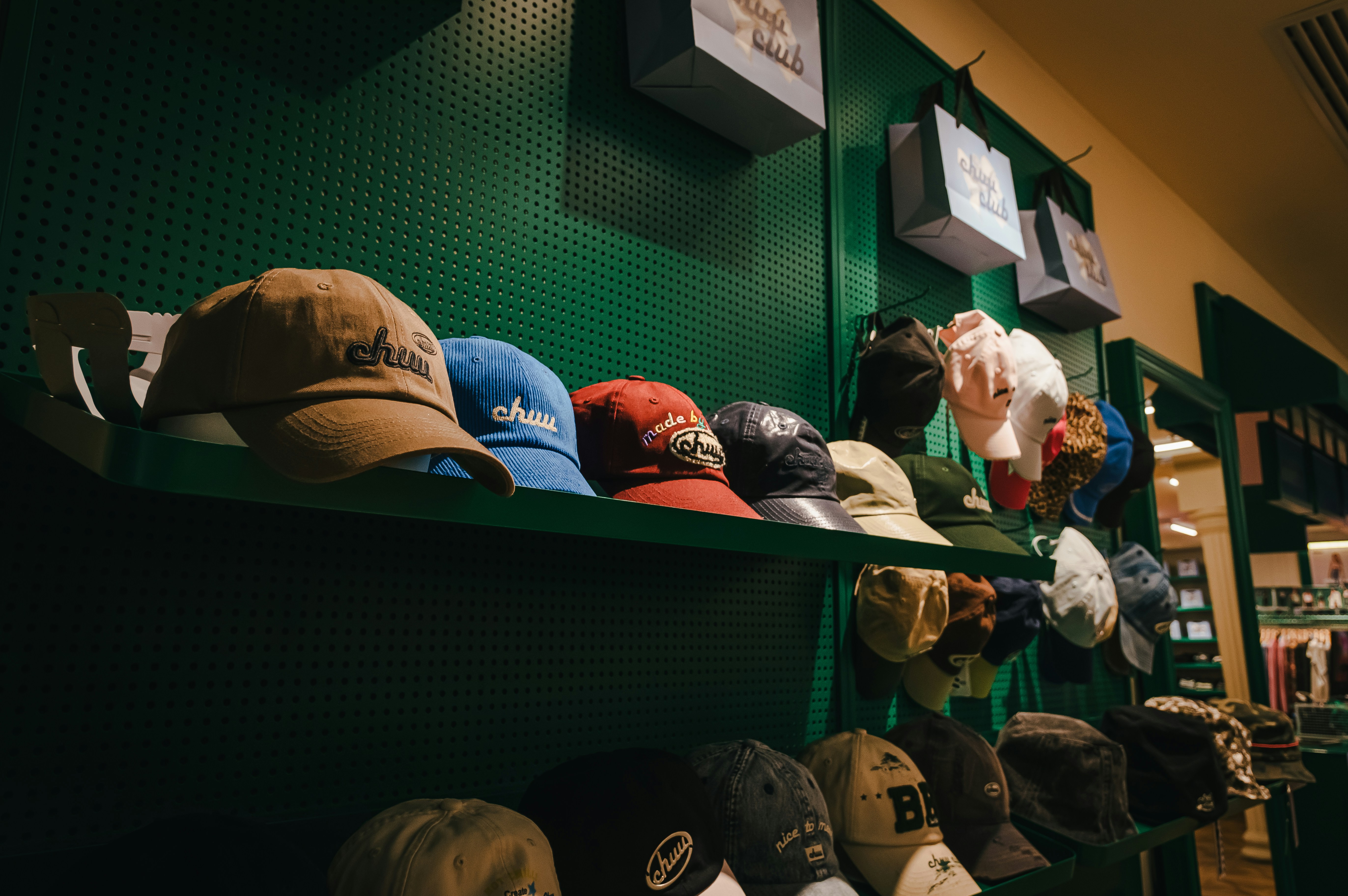 Hats are displayed on shelves in a store.