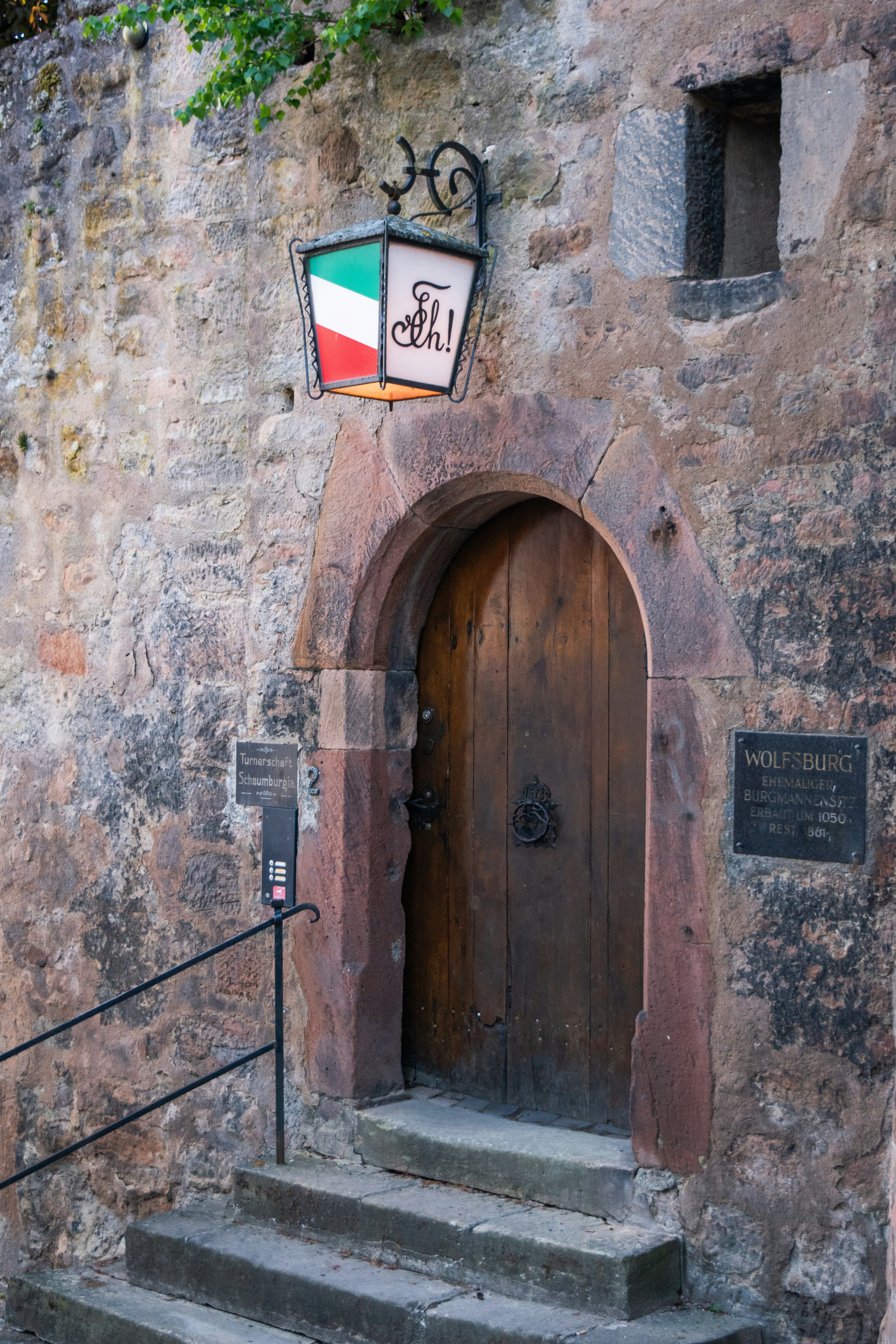Lantern of Color Above a Timeworn Archway
