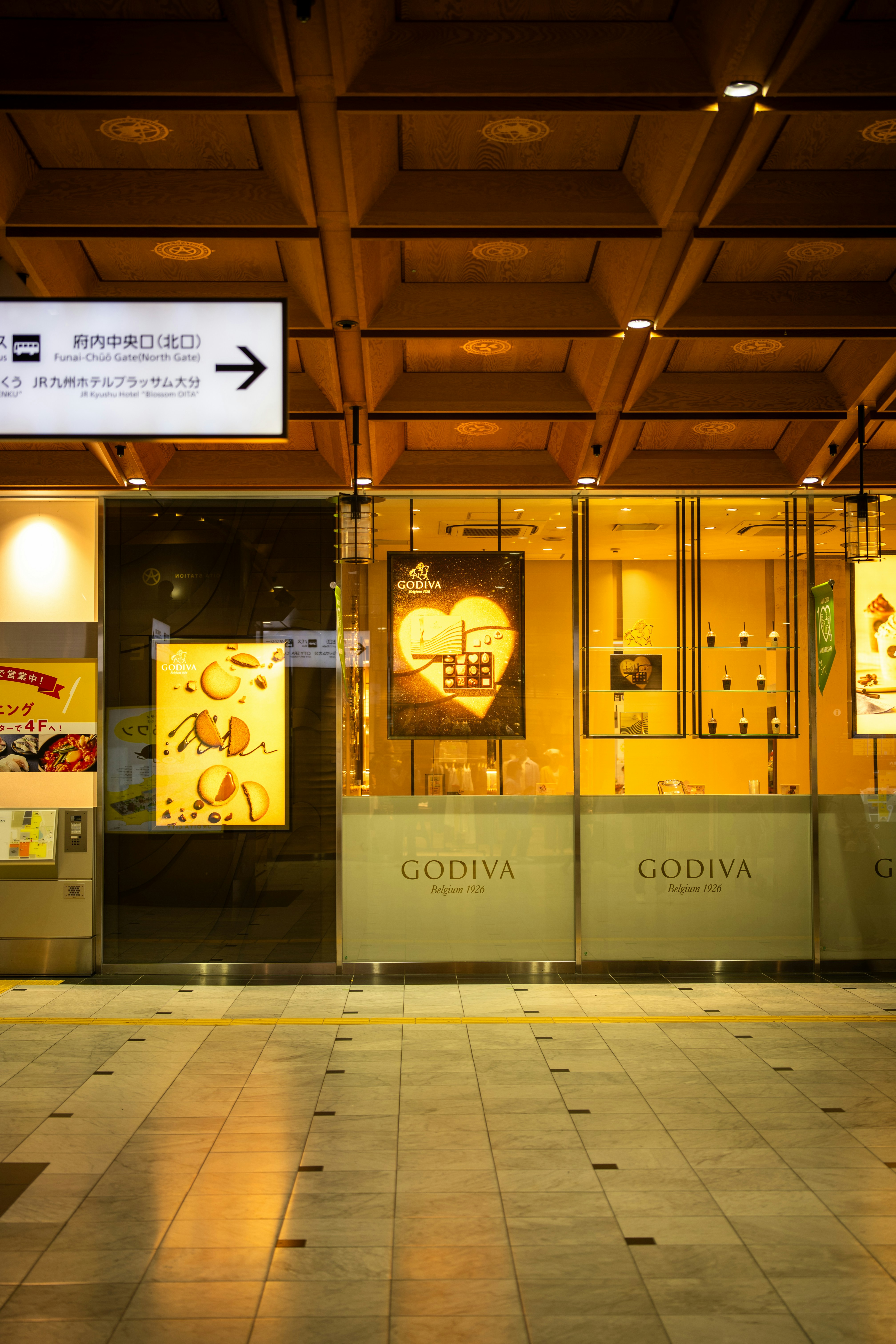 A godiva store is seen inside a building. photo – Free Building Image ...