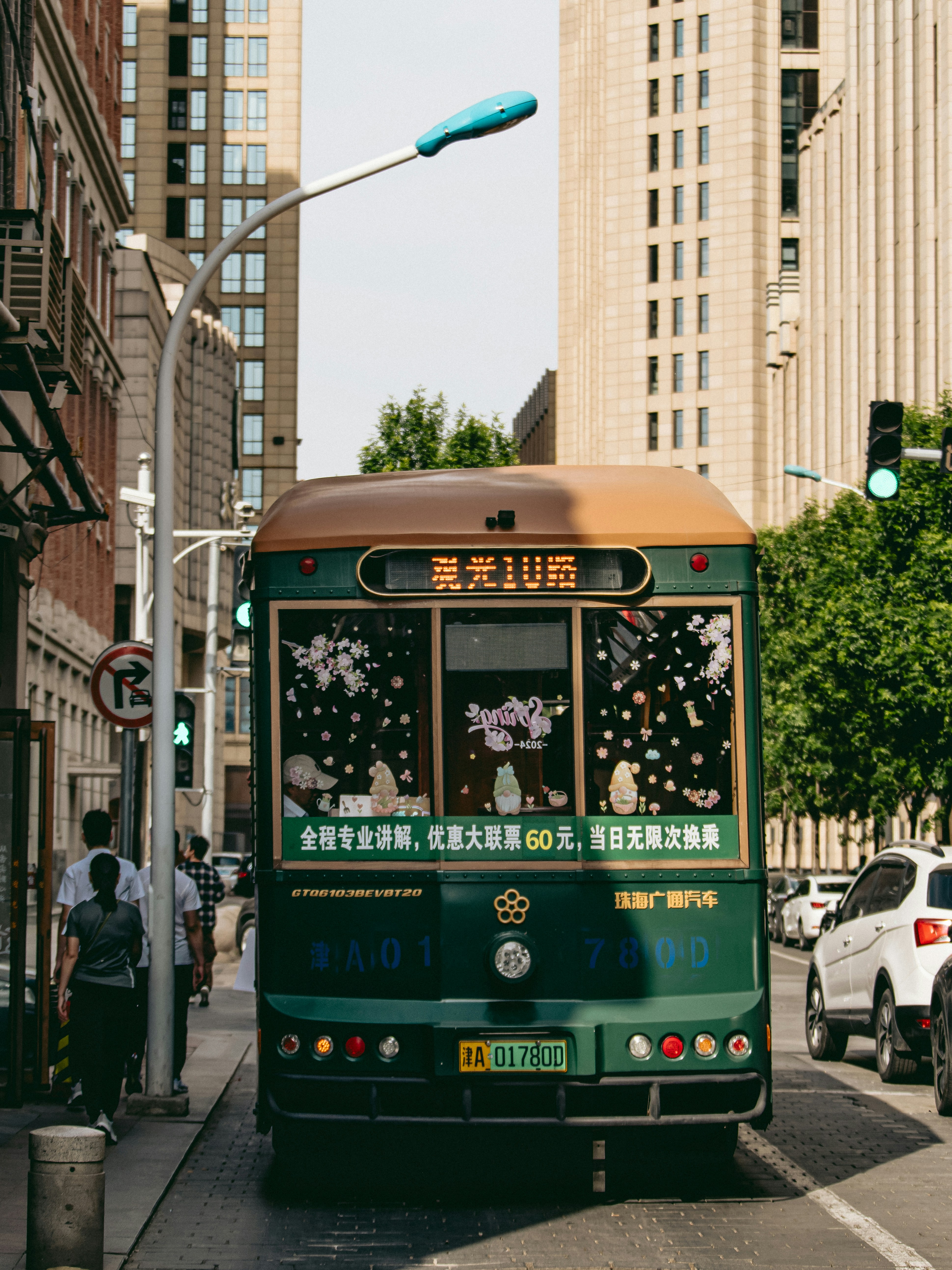 City Bus in Glassy Afternoon: A Neon-Blue Accent Amid Tall Downtown Towers