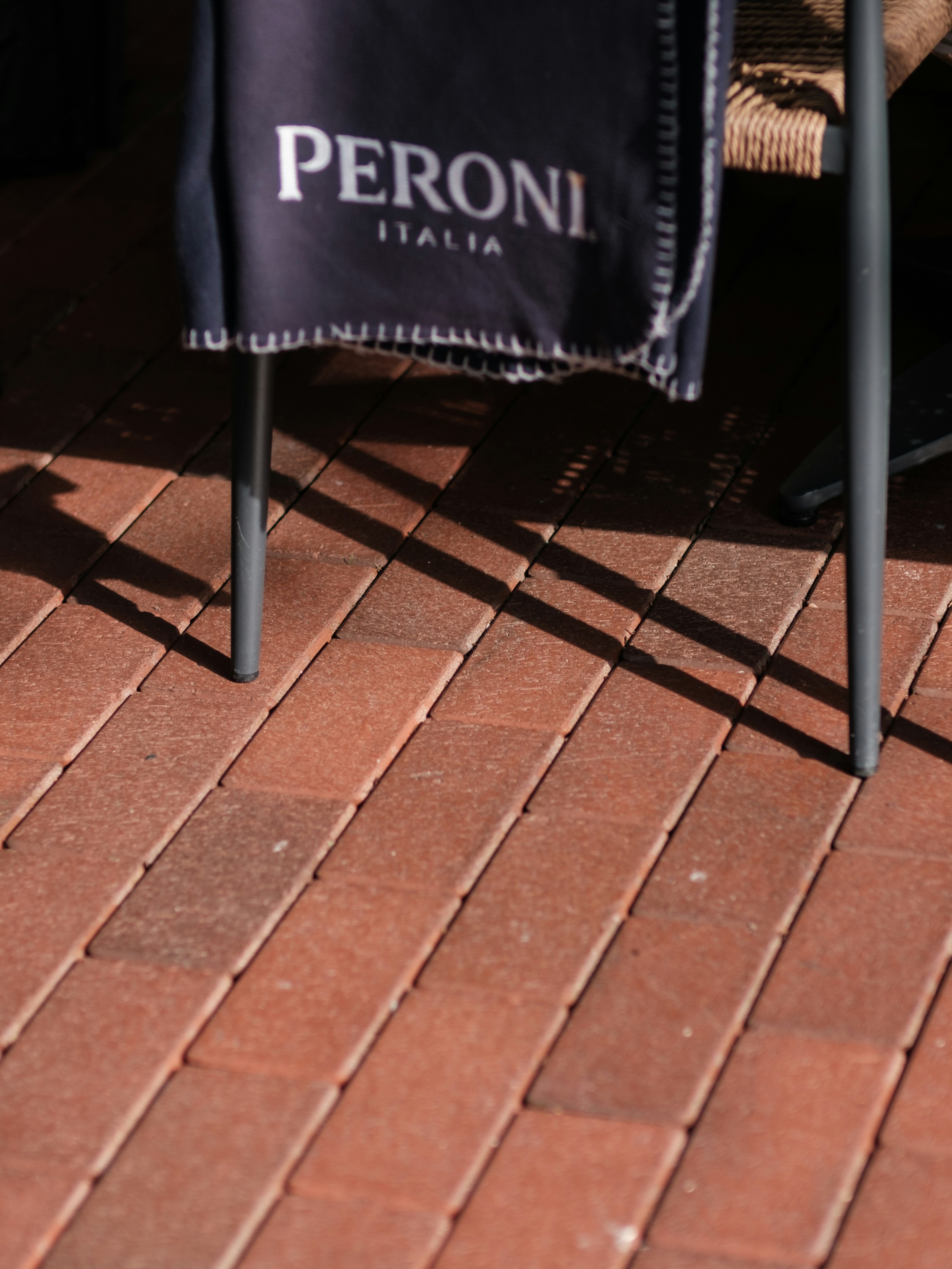 Peroni Banner Draped Over Rustic Café Terrace