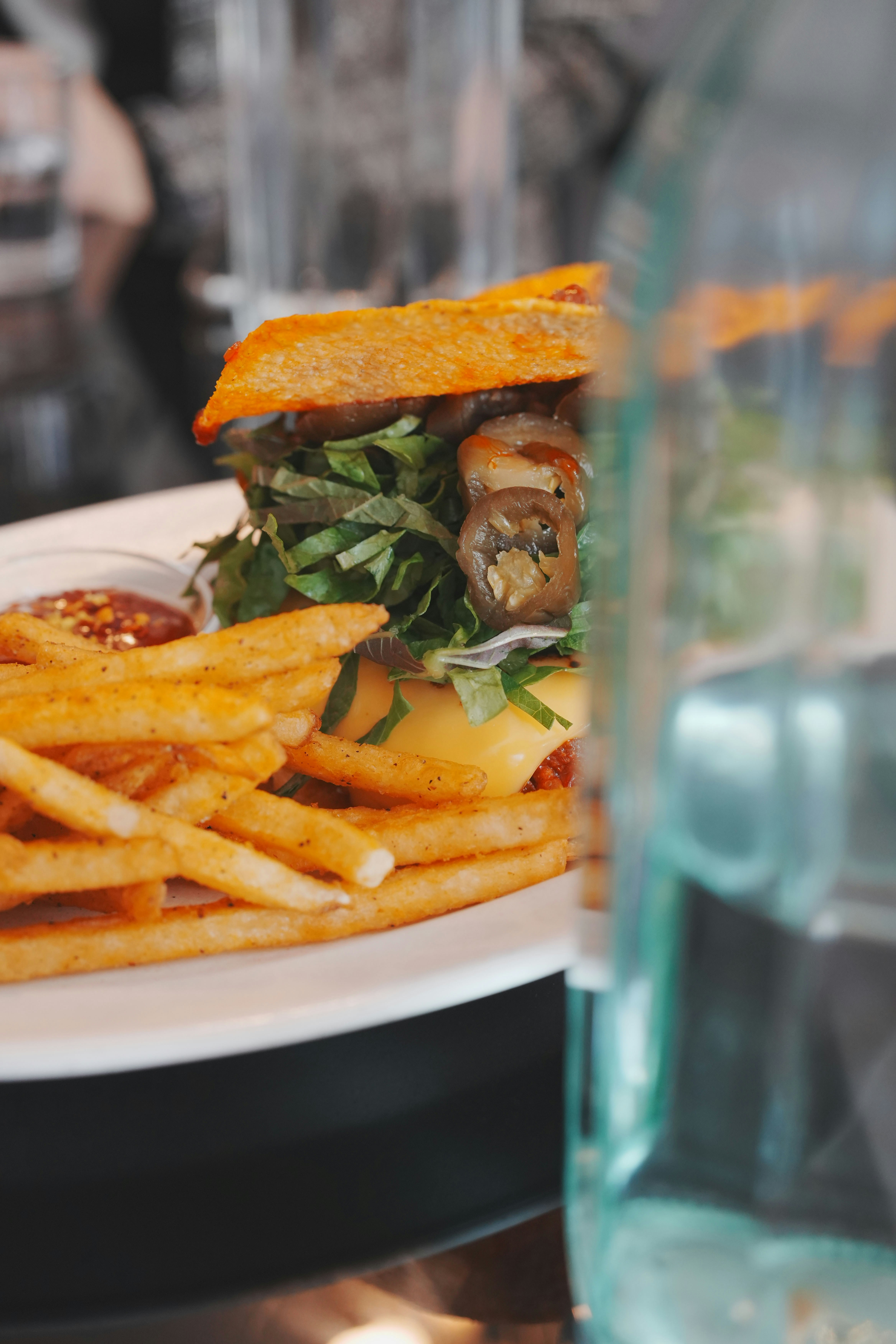 Delicious burger with fries served on a plate. photo – Free Food Image ...